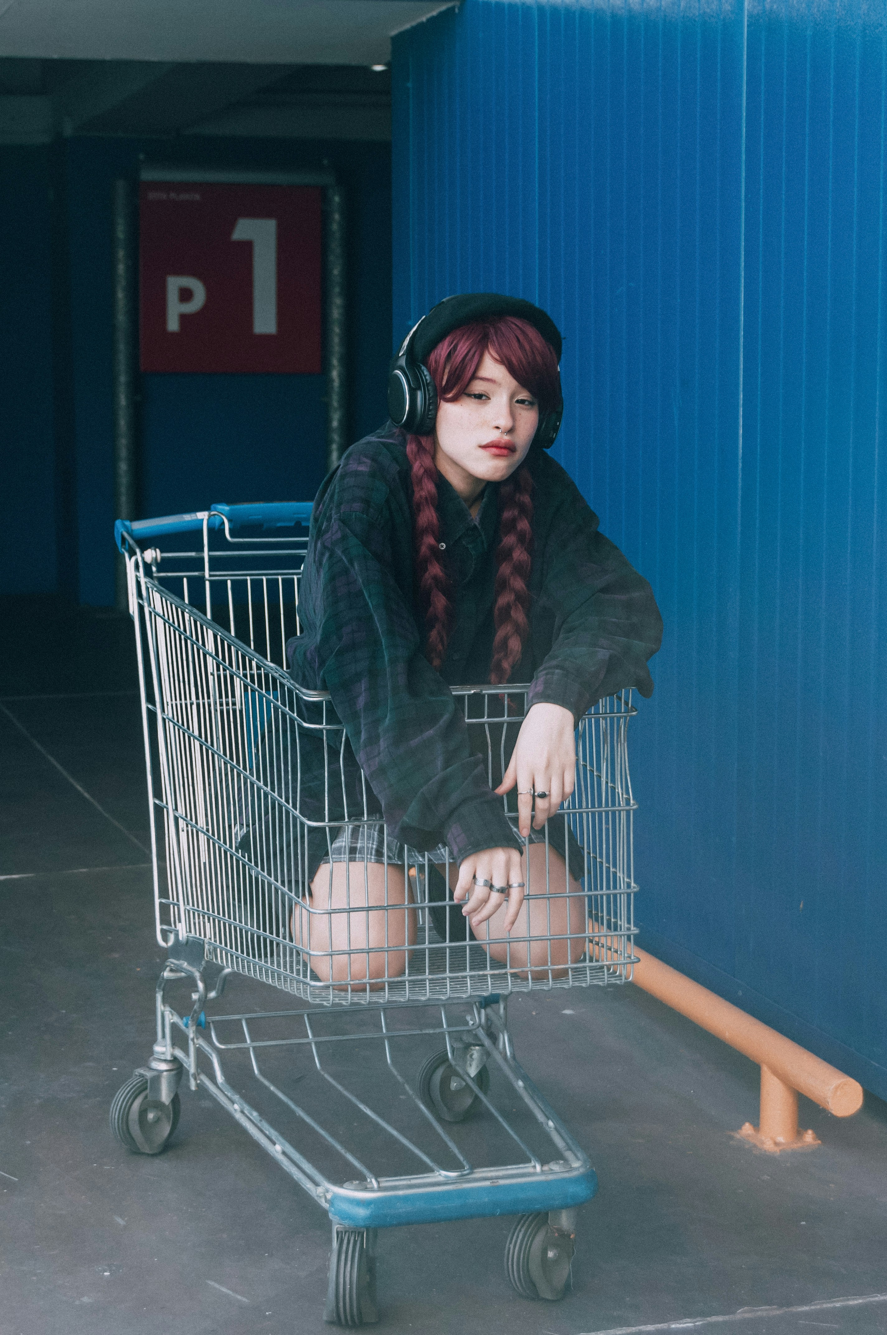 Braids in the Cart: A Quiet Portrait under Blue Industrial Light