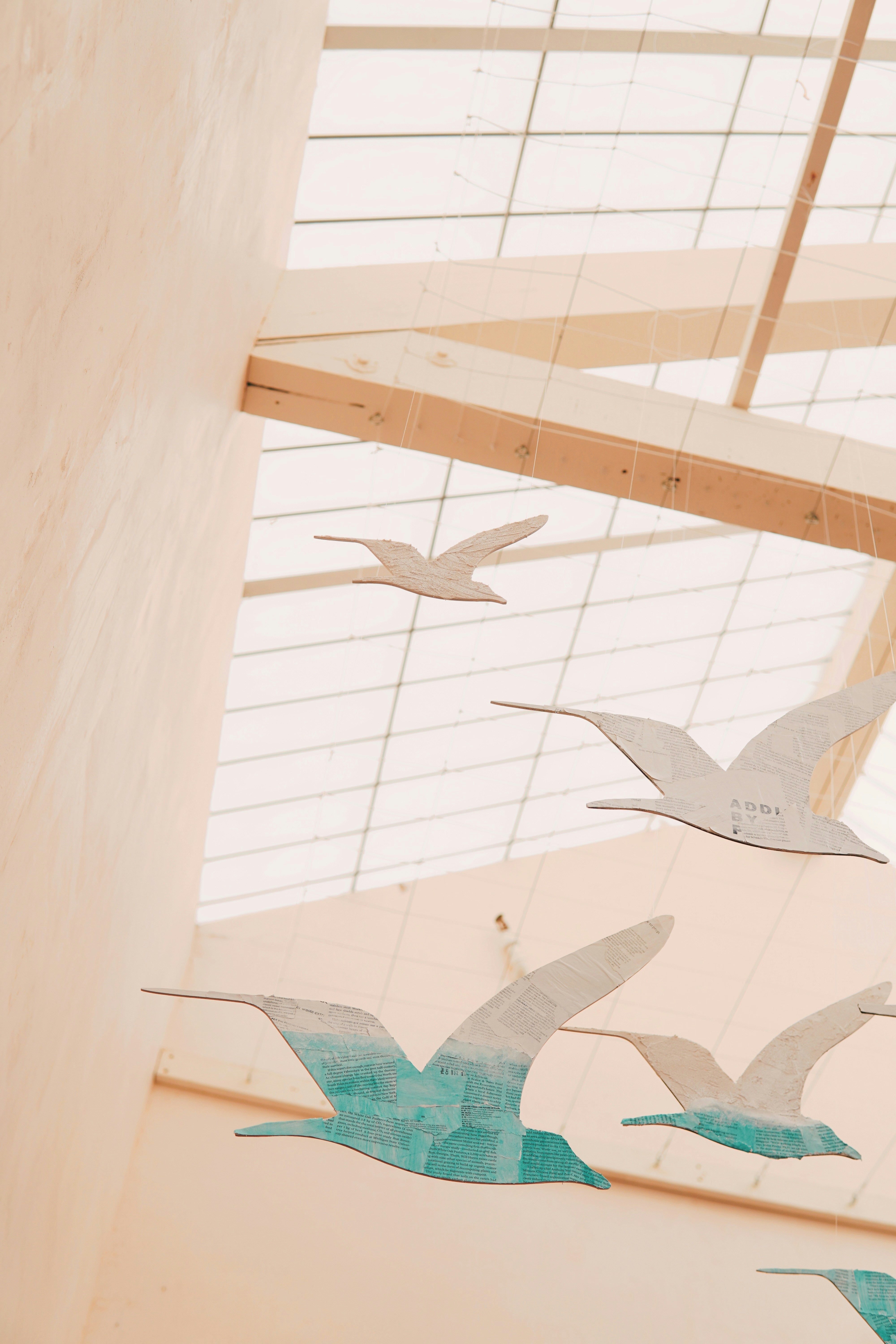 Peach-Tinted Atrium: Paper Birds in Gentle Suspension