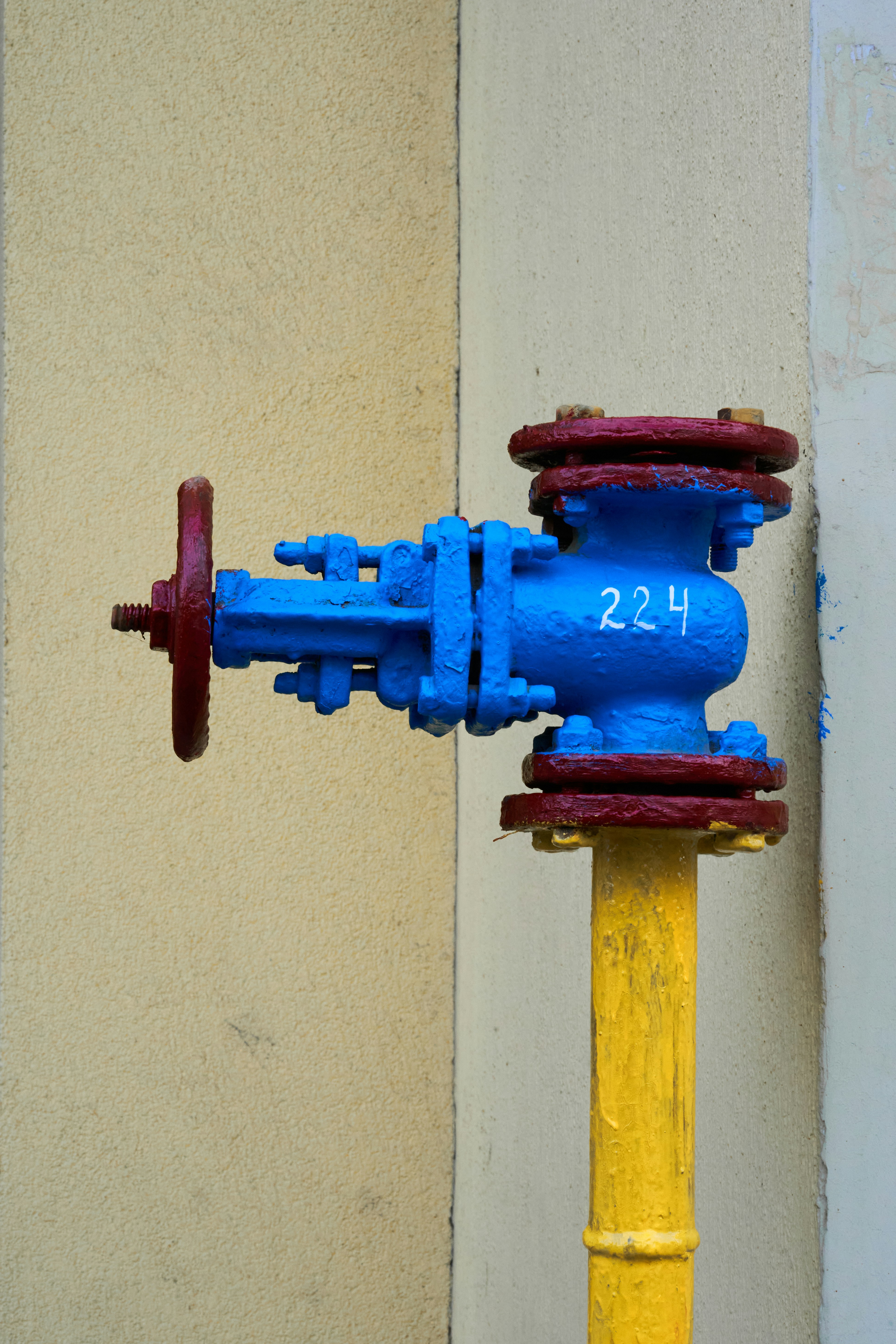 A blue fire hydrant sitting next to a yellow pole photo – Free Fire ...