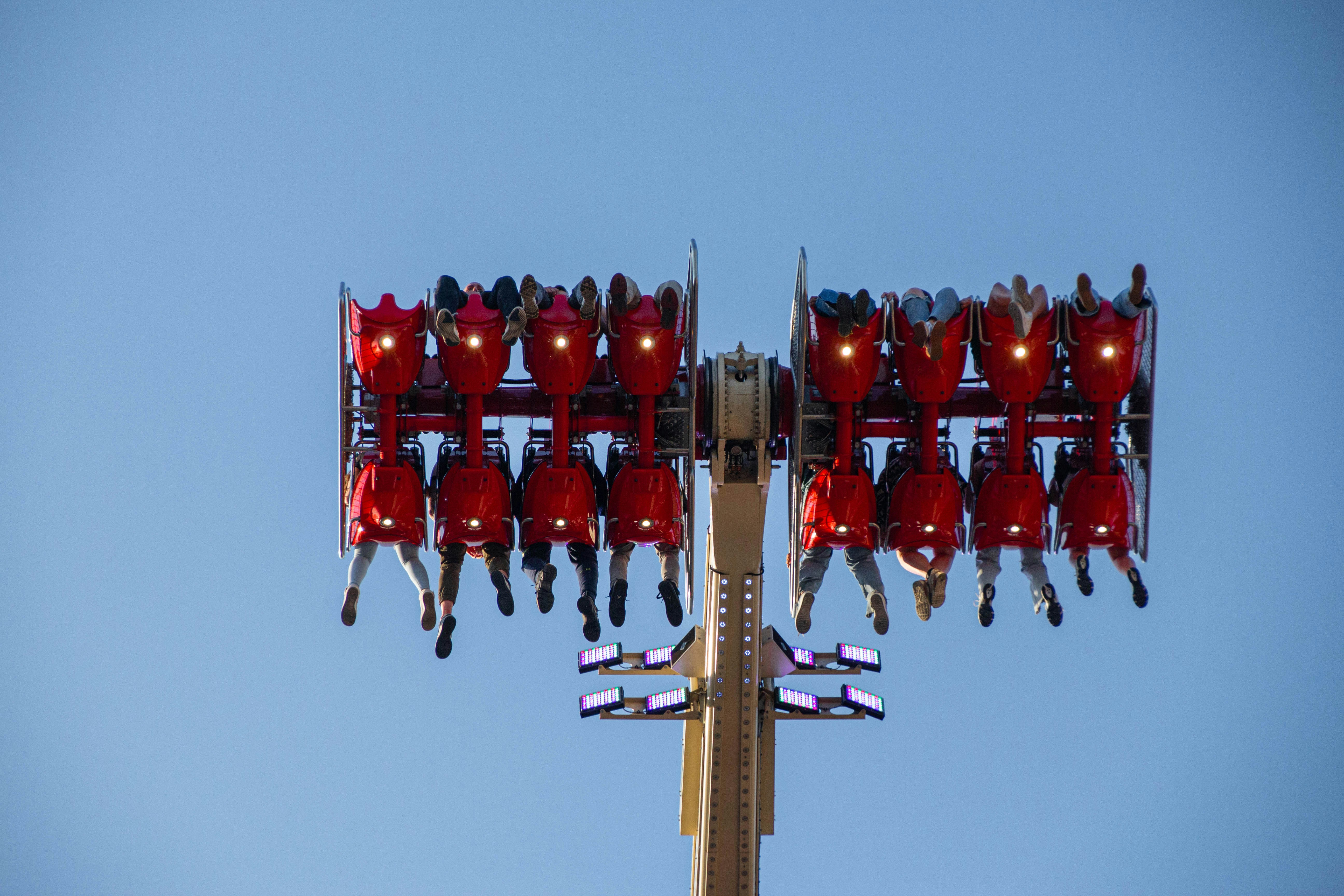 Vertical Axis of Red Carriages Against a Clear Blue Sky