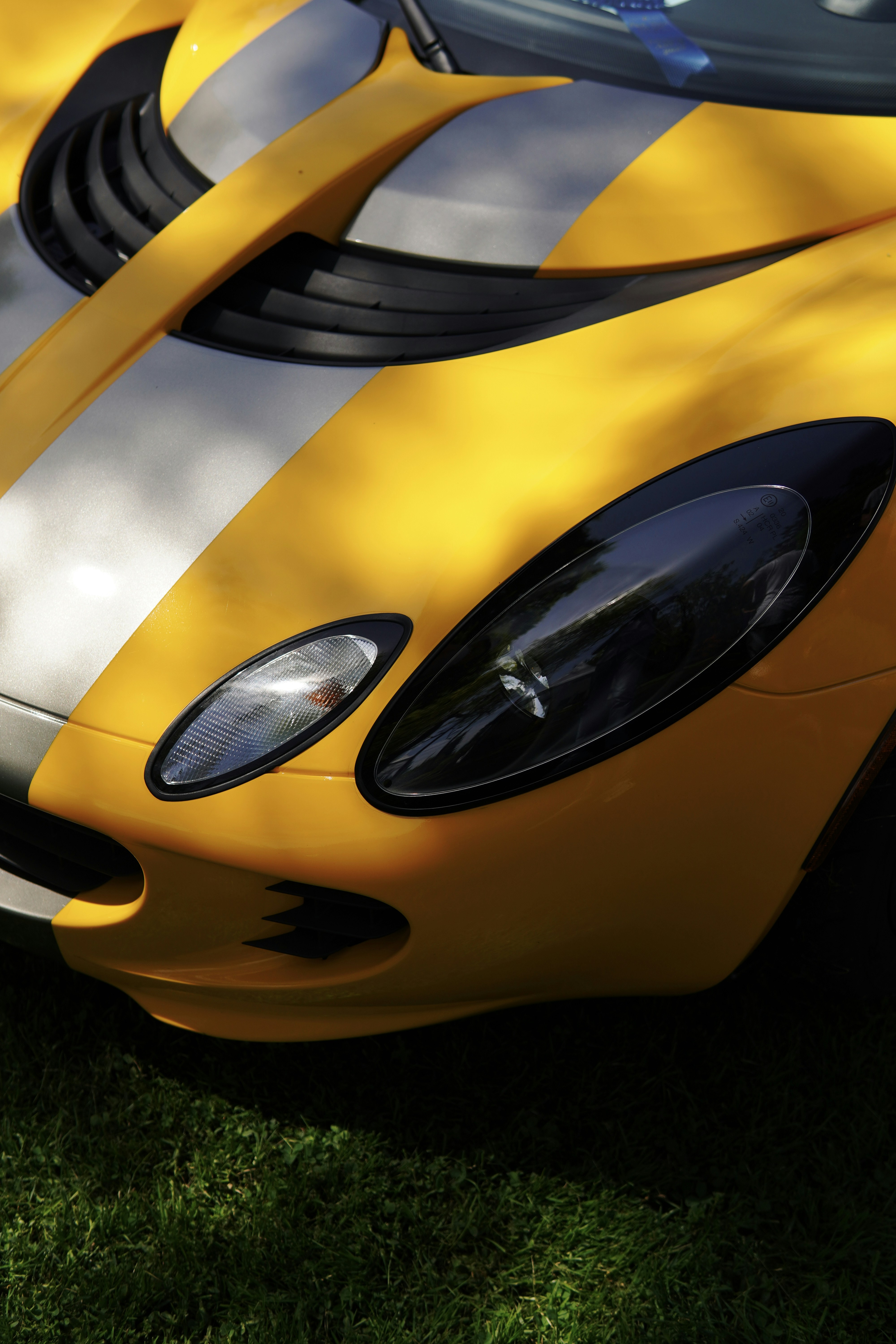 a-close-up-of-a-sports-car-on-a-grass-field-photo-free-bc-image-on
