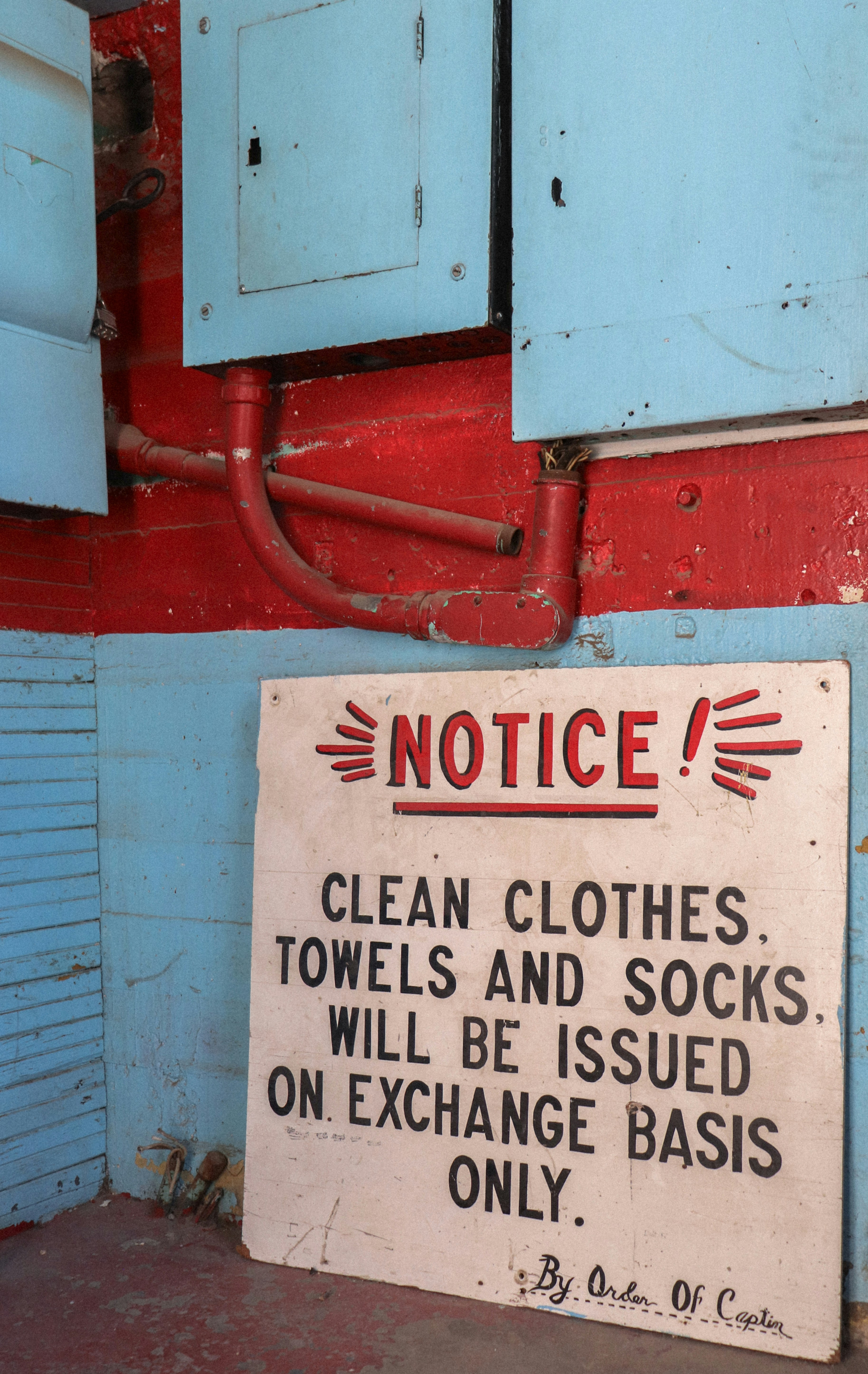 Exchange-Only Notice on a Weathered Red-Blue Utility Wall