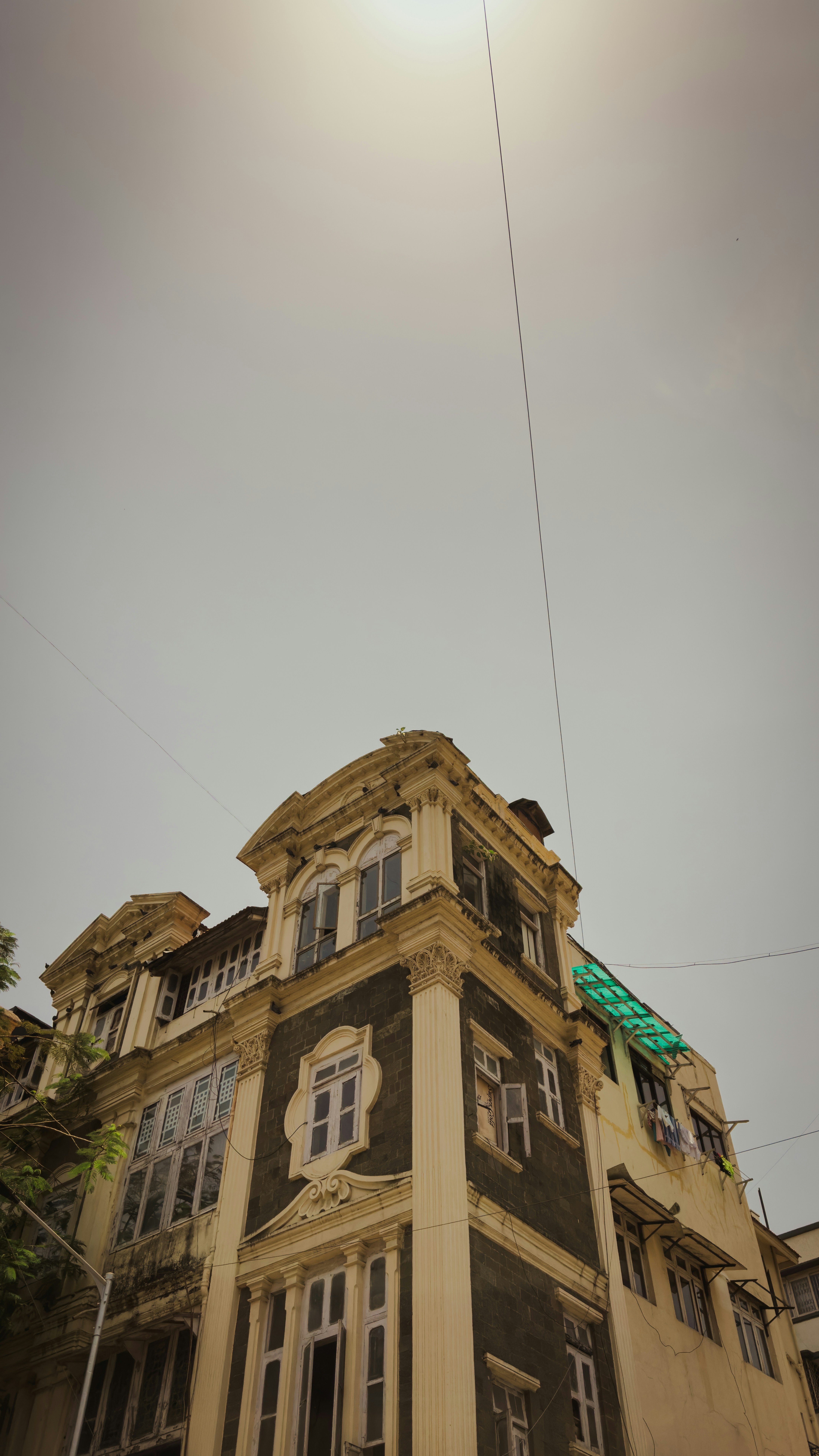 A building with a kite flying in the air photo – Free Building Image on ...
