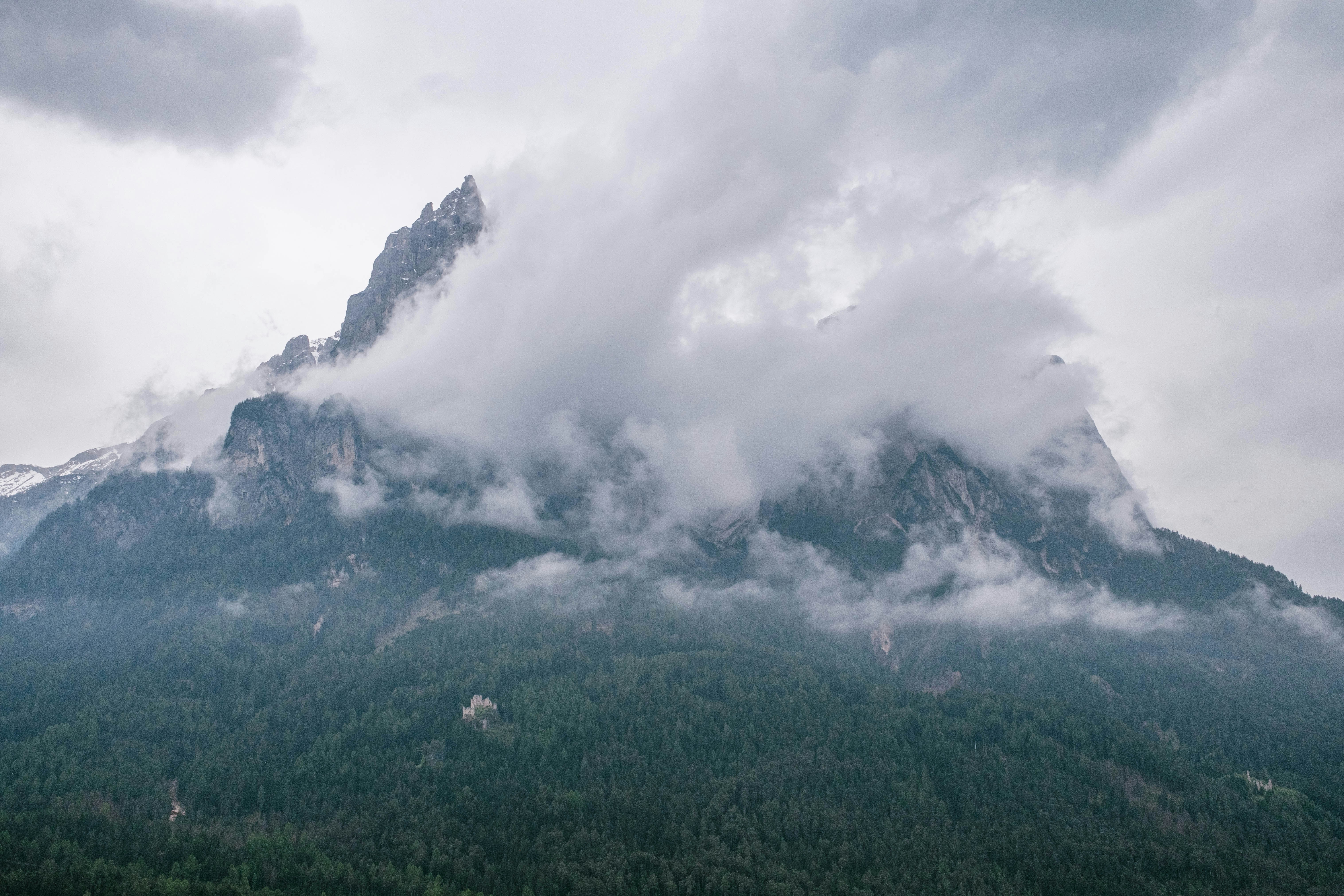 Cloud-Kissed Peak Above Verdant Slopes