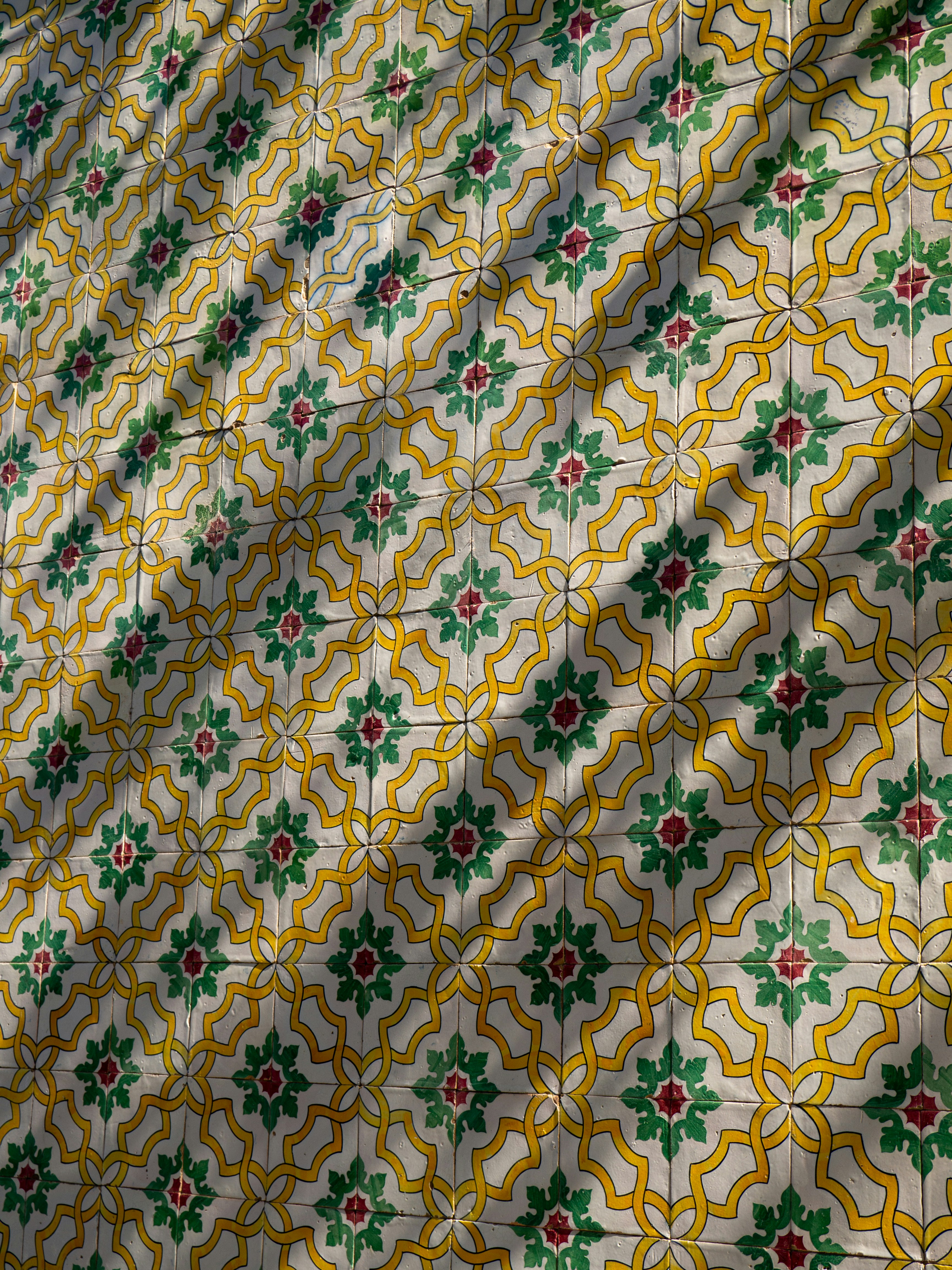 Golden Lattice Starbursts: a Close-Up of Green-Accented Tile Pattern