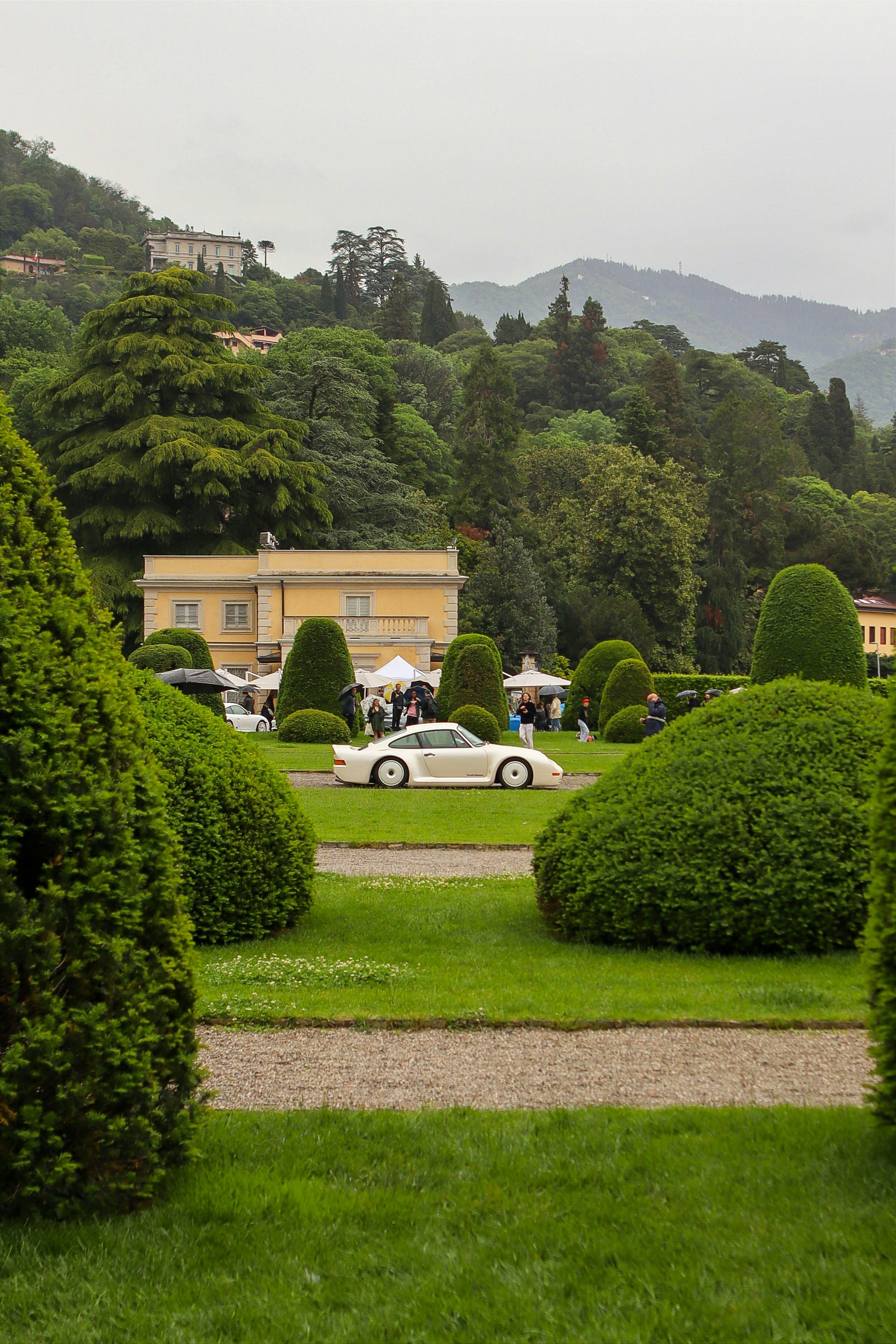 White Vintage Car at the Heart of a Pruned Green Parterre