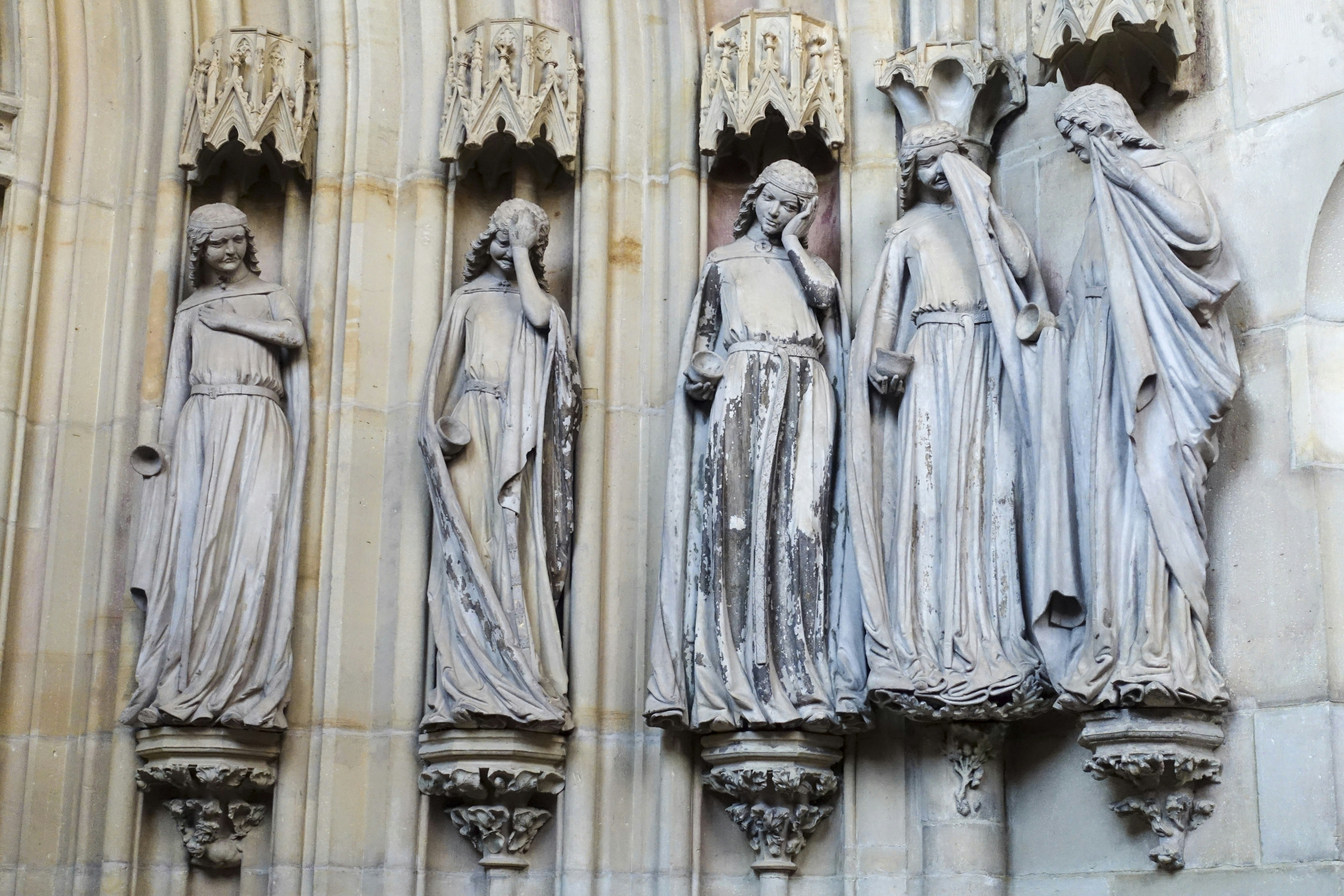A group of statues on the side of a building photo – Free Woman Image ...