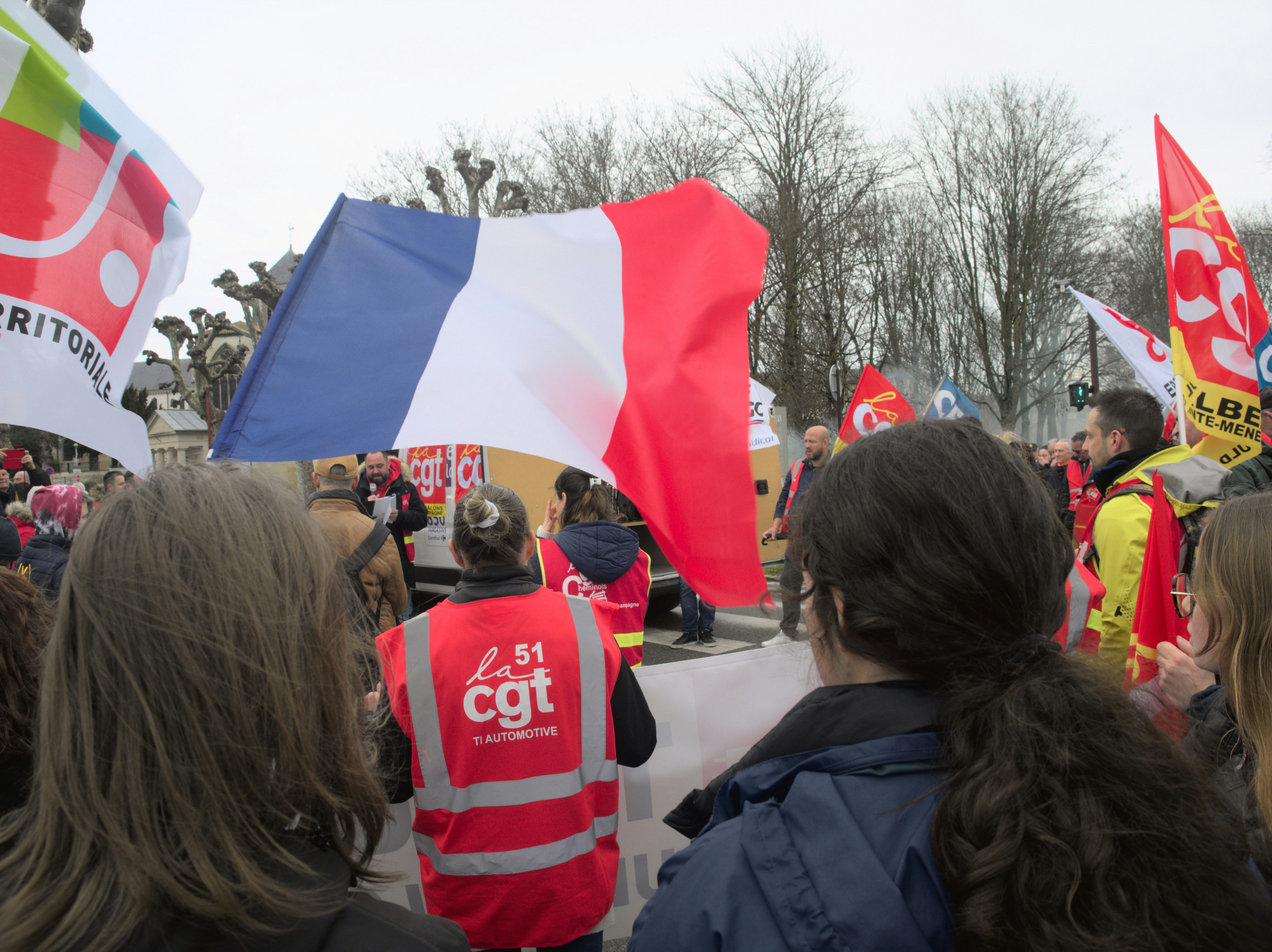 A group of people holding flags and signs photo – Free Protest Image on ...