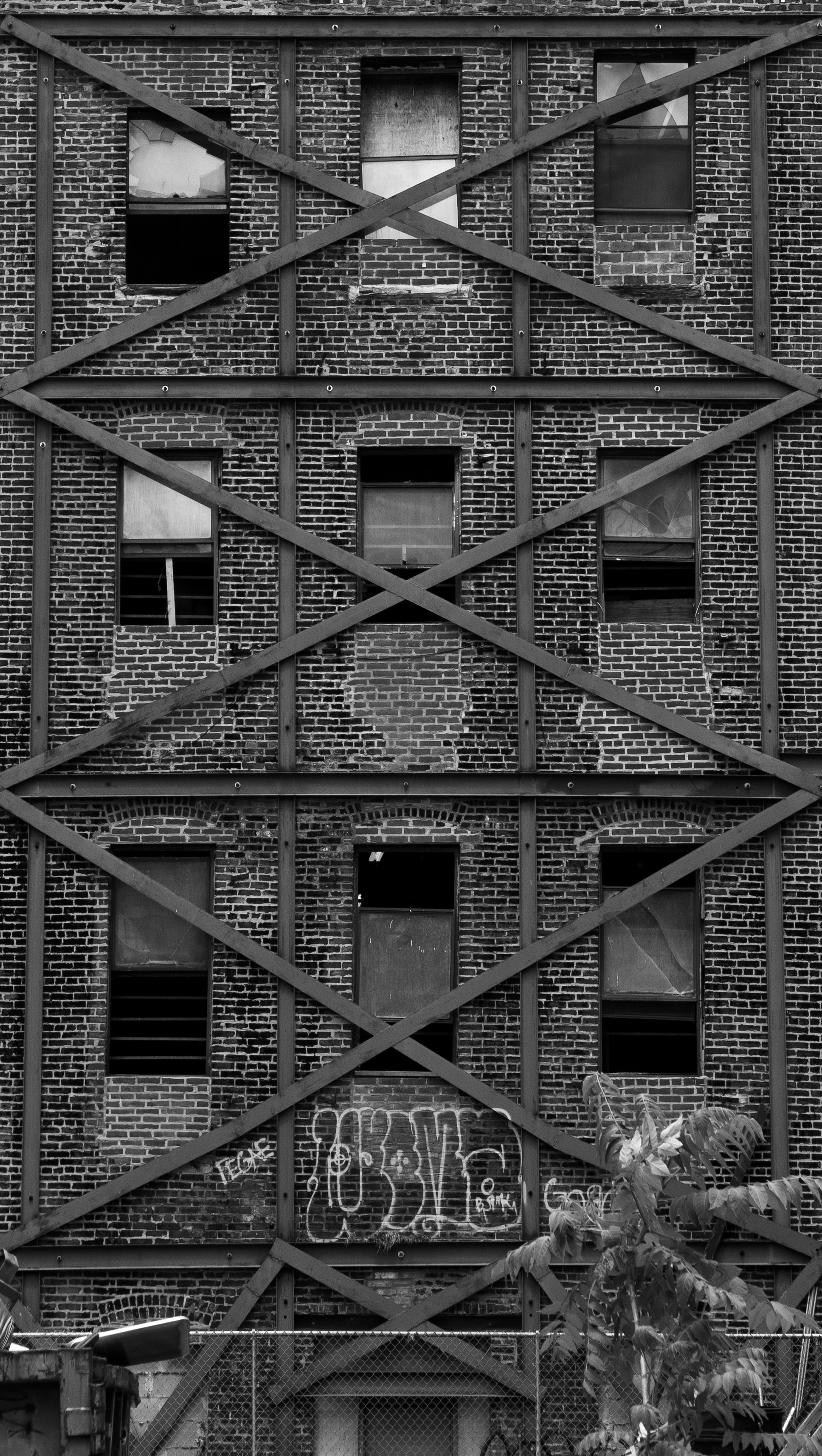 a black and white photo of a building with graffiti on it