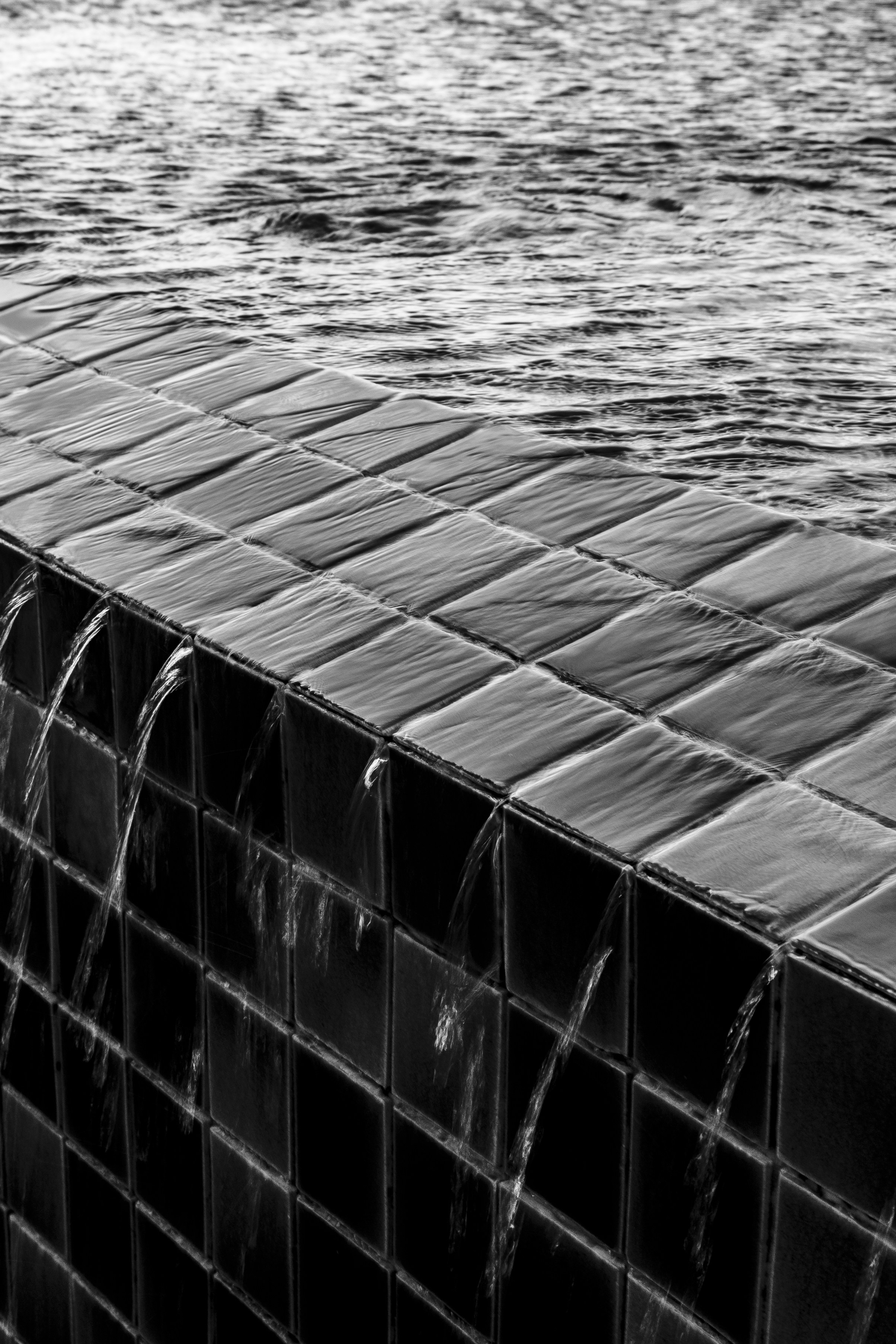Industrial shoreline: geometric waveproofing meets reflective sea