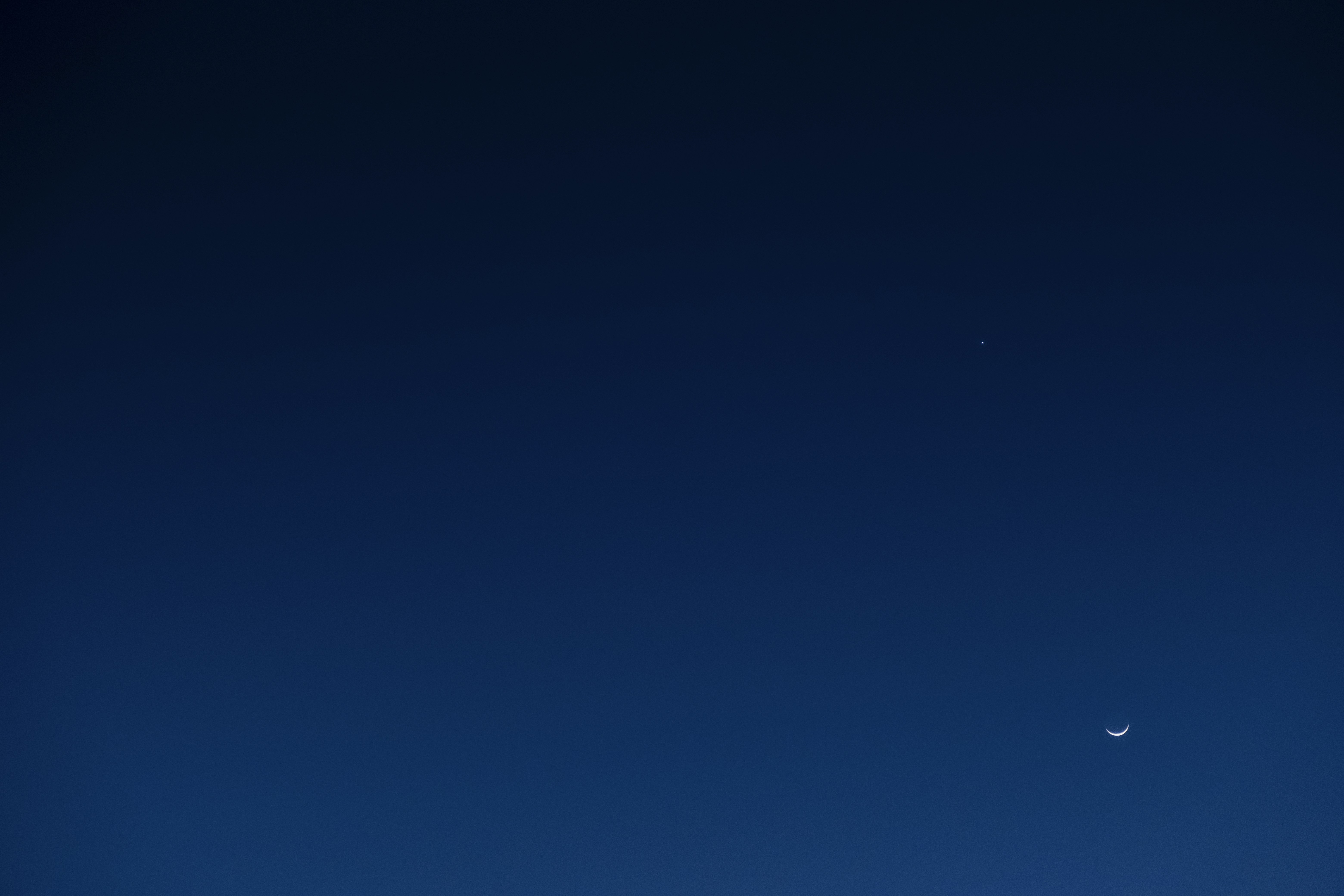 In the ink of the night, a solitary moon whispers tales of the cosmos to a lone star, narrating the profound simplicity of existence. | a plane flying in the sky with a moon in the background