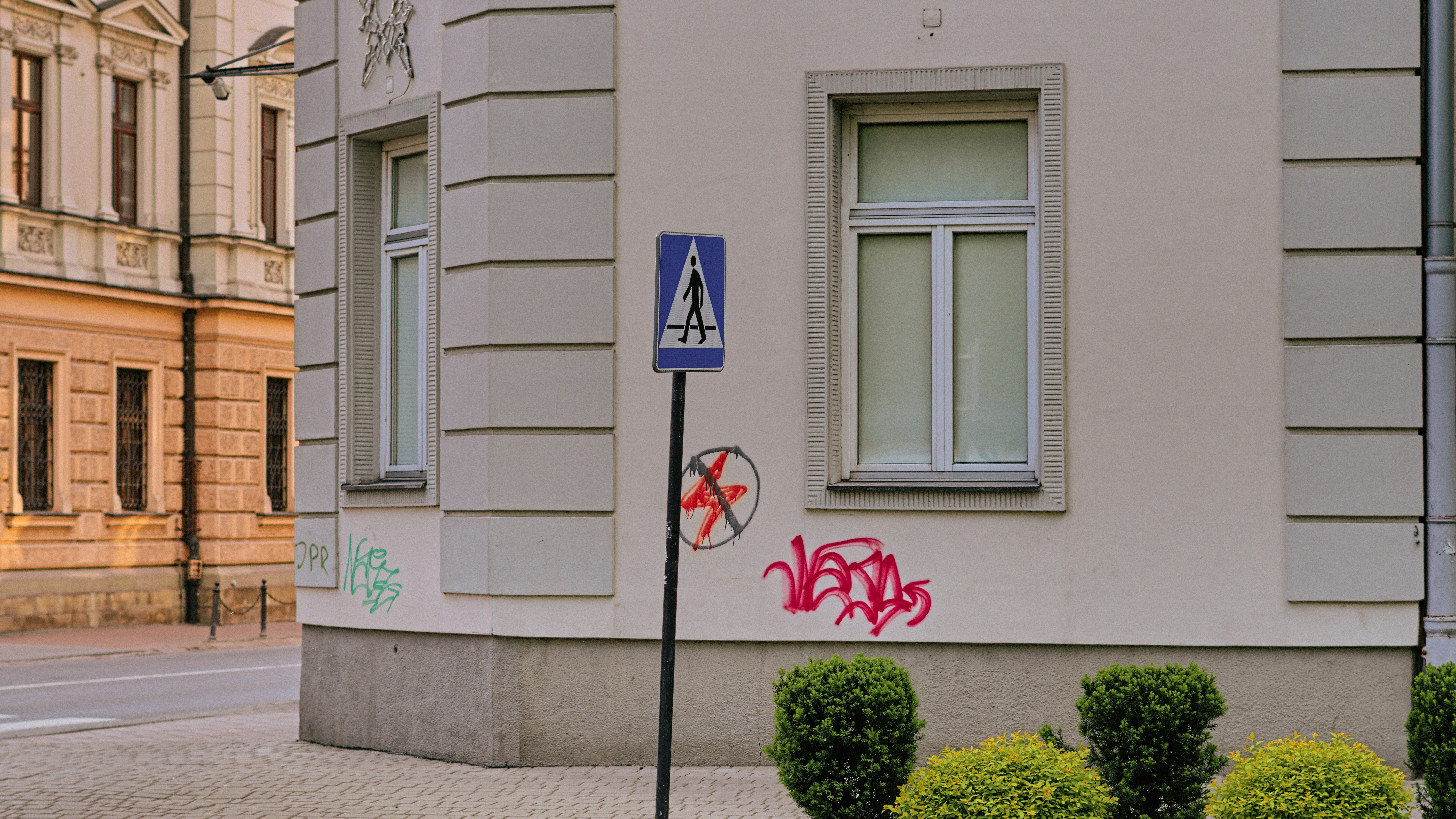 A street sign on a pole in front of a building photo – Free Poland ...