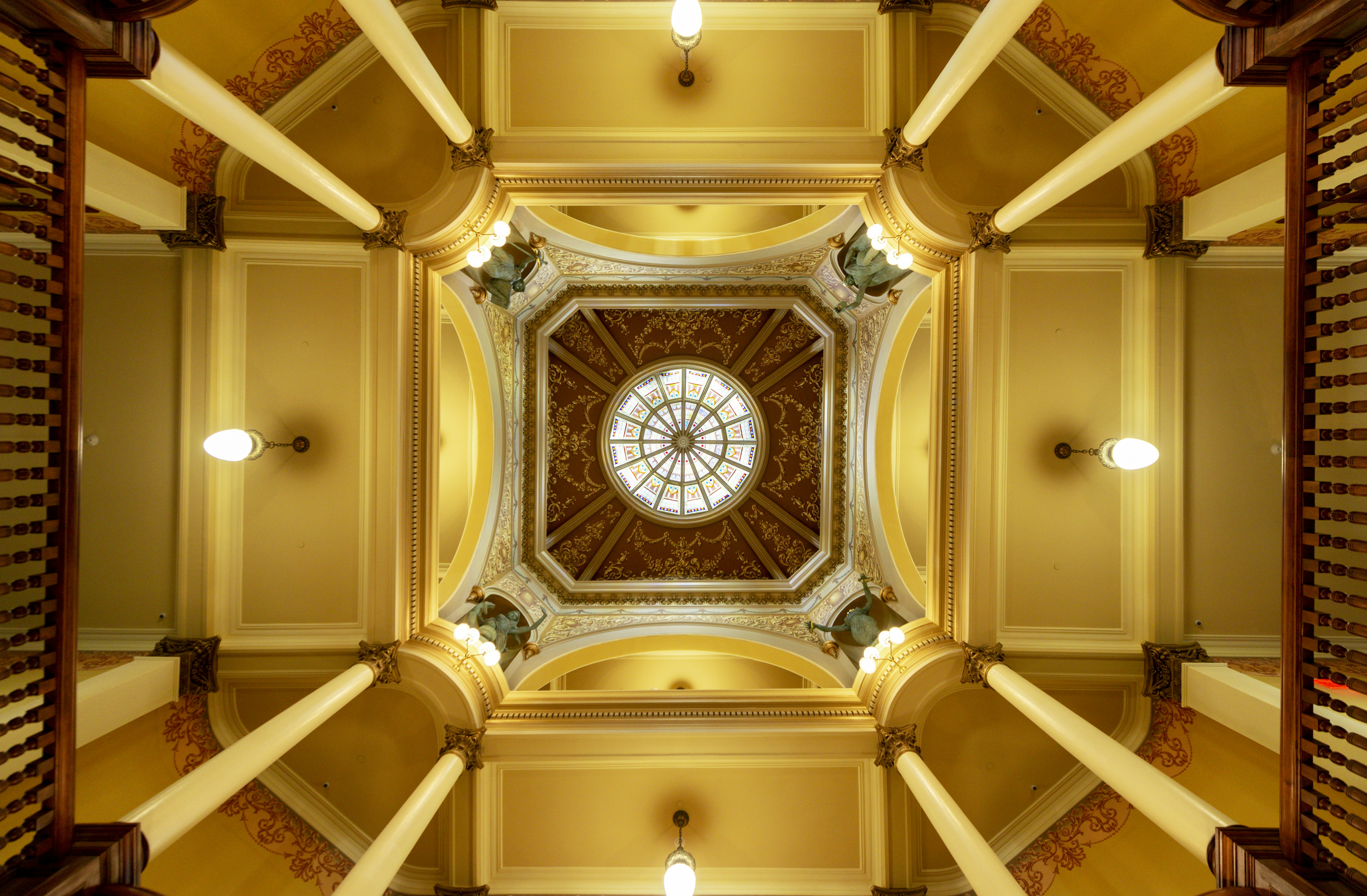 View of the Wyoming State Capitol's dome within its rotunda, located in Cheyenne, WY. | a view of a ceiling in a building