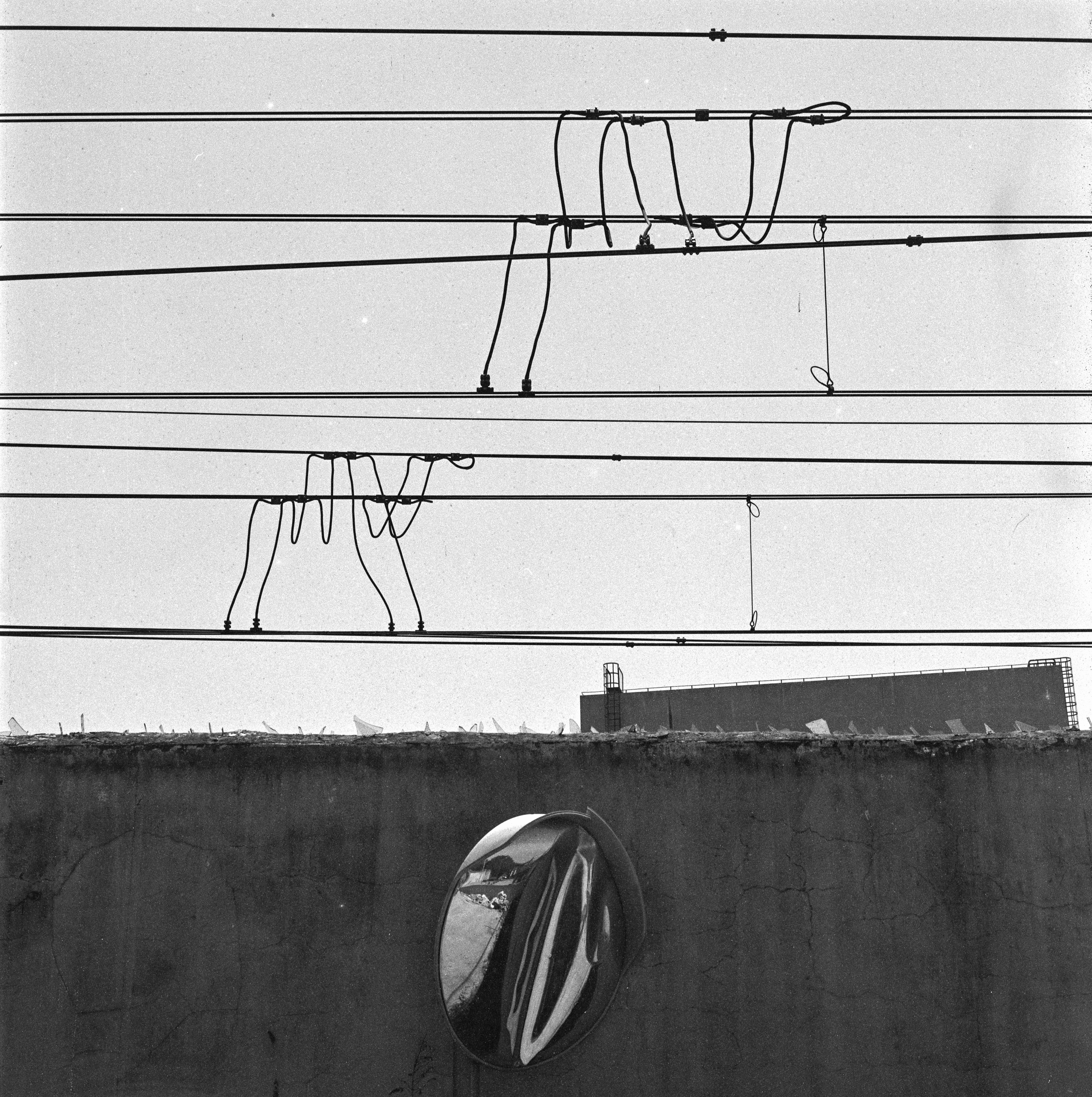 Circular Mirror in a Wirescape: Reflection Beneath the Power Lines