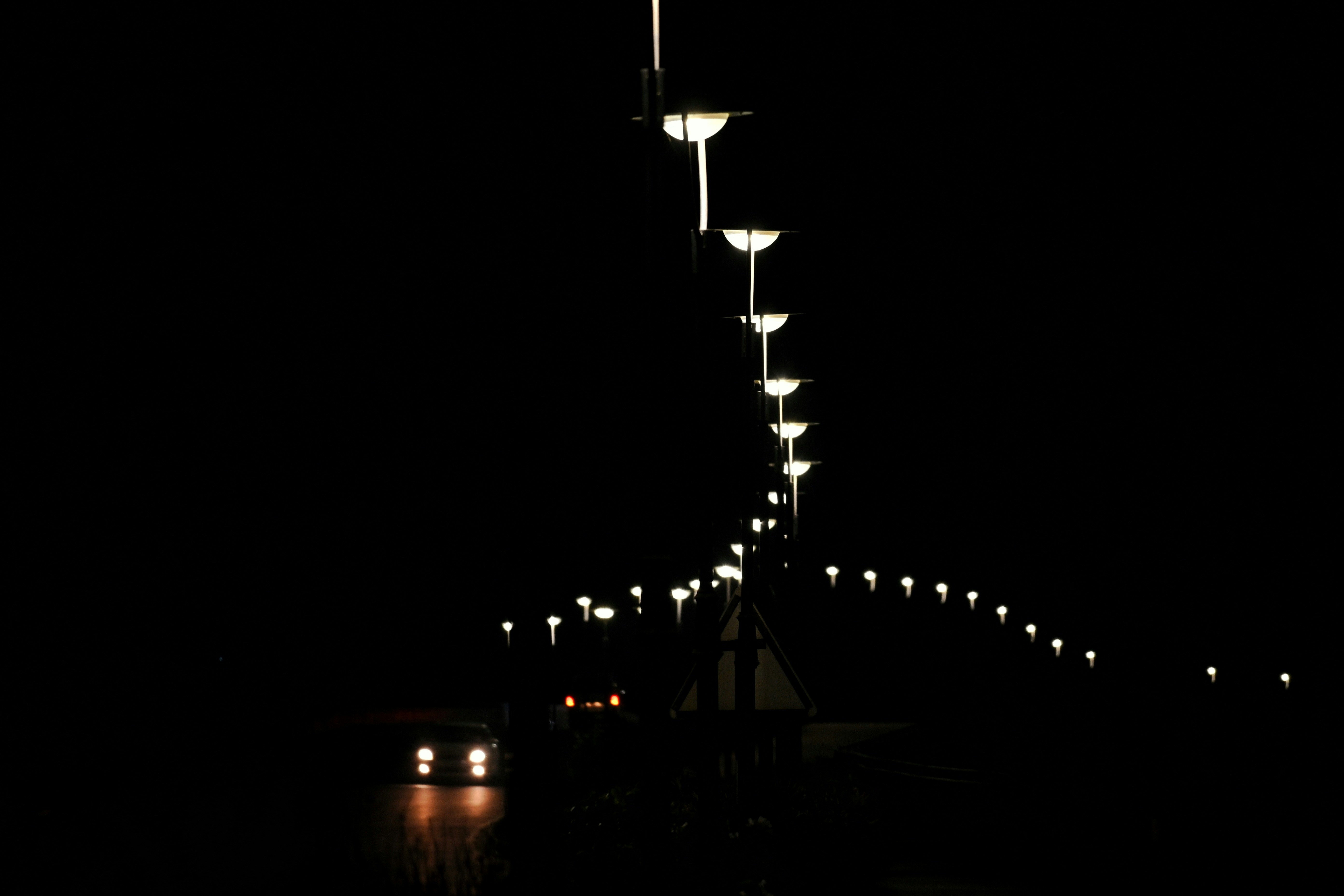 Vanishing Glow: Night Drive Along a Symmetrical Lantern Row