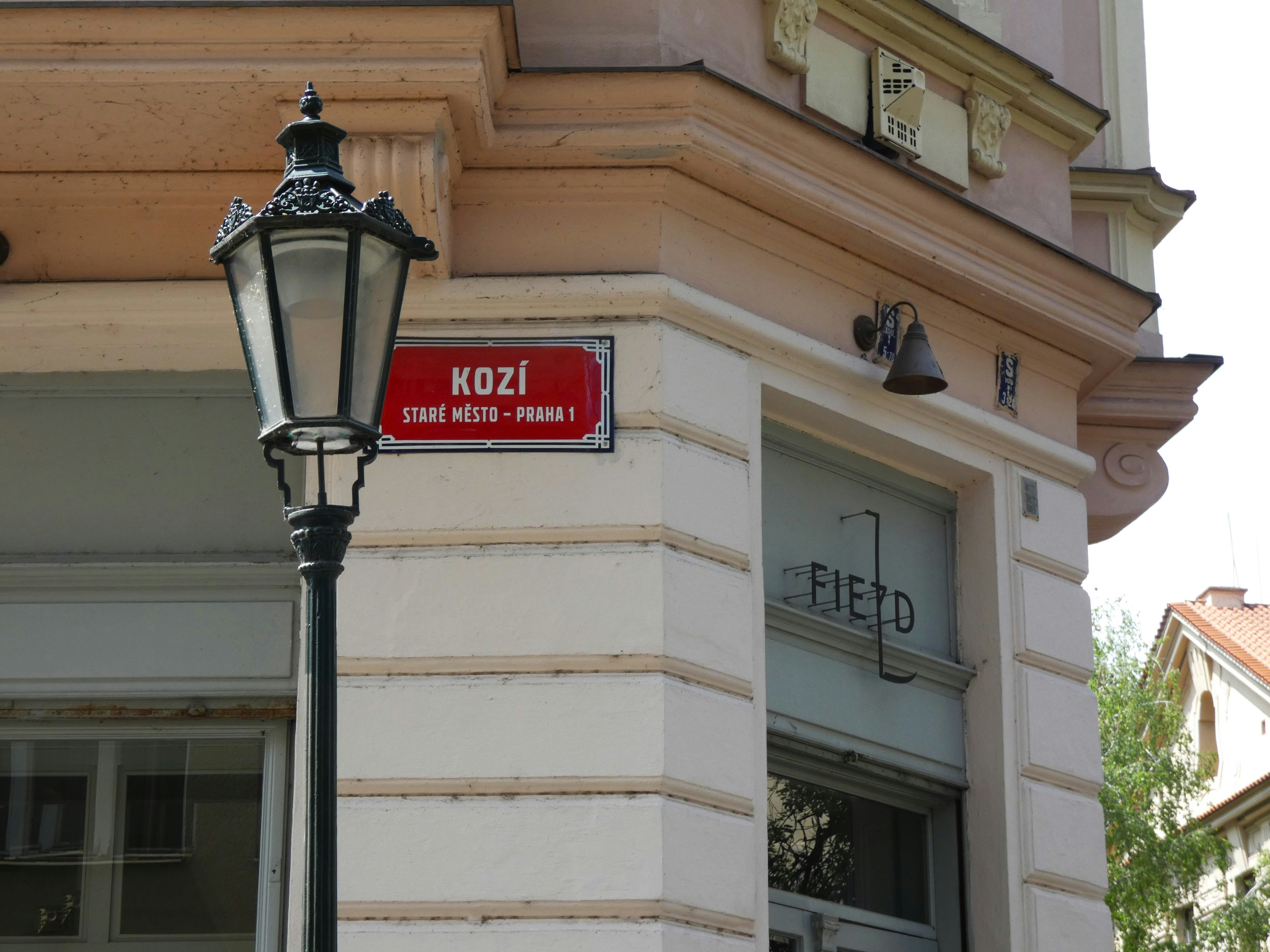 A red street sign sitting on the side of a building photo – Free ...