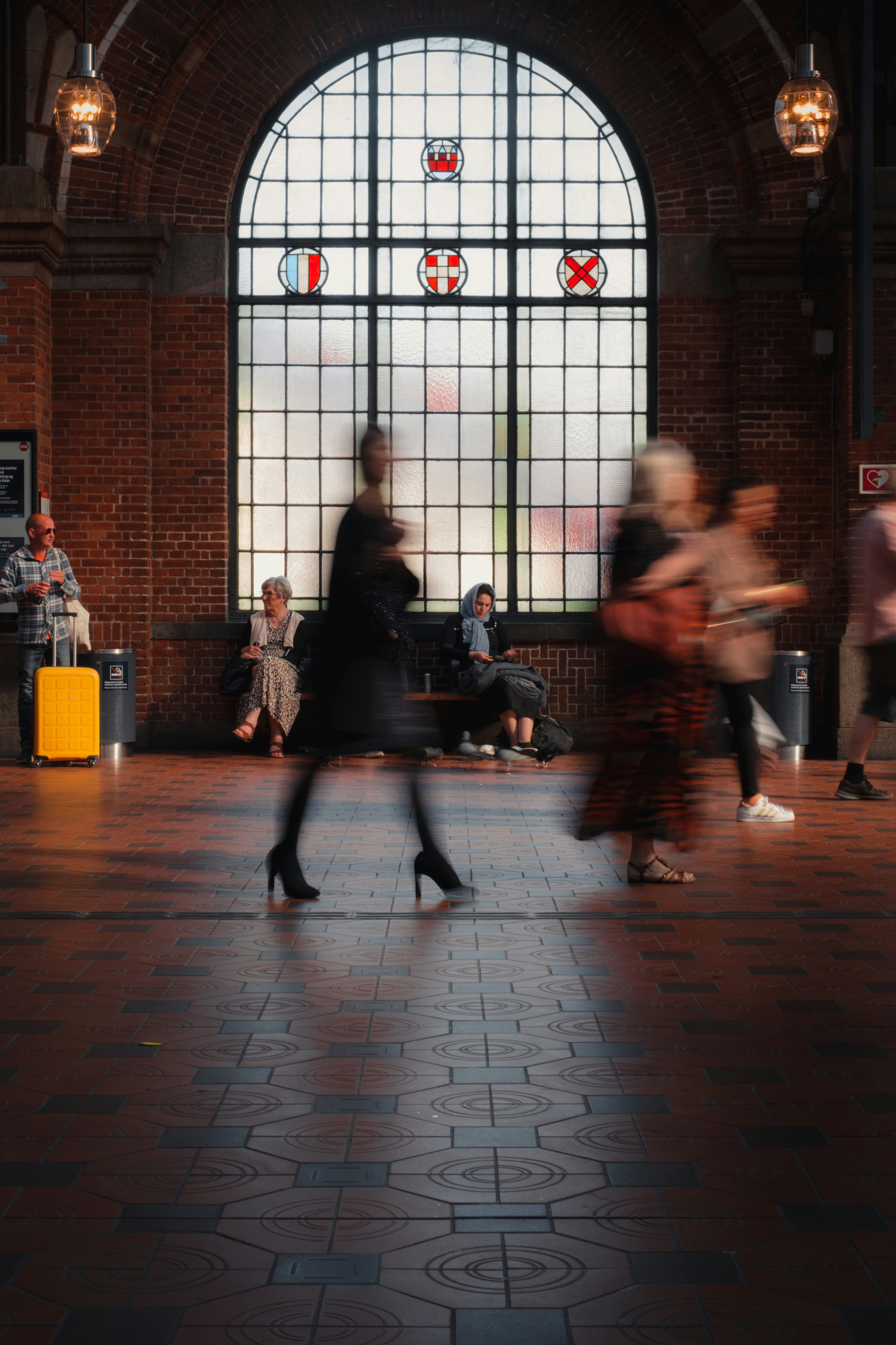 Motion in the Station Hall: Blurred Passersby Under the Arched Window