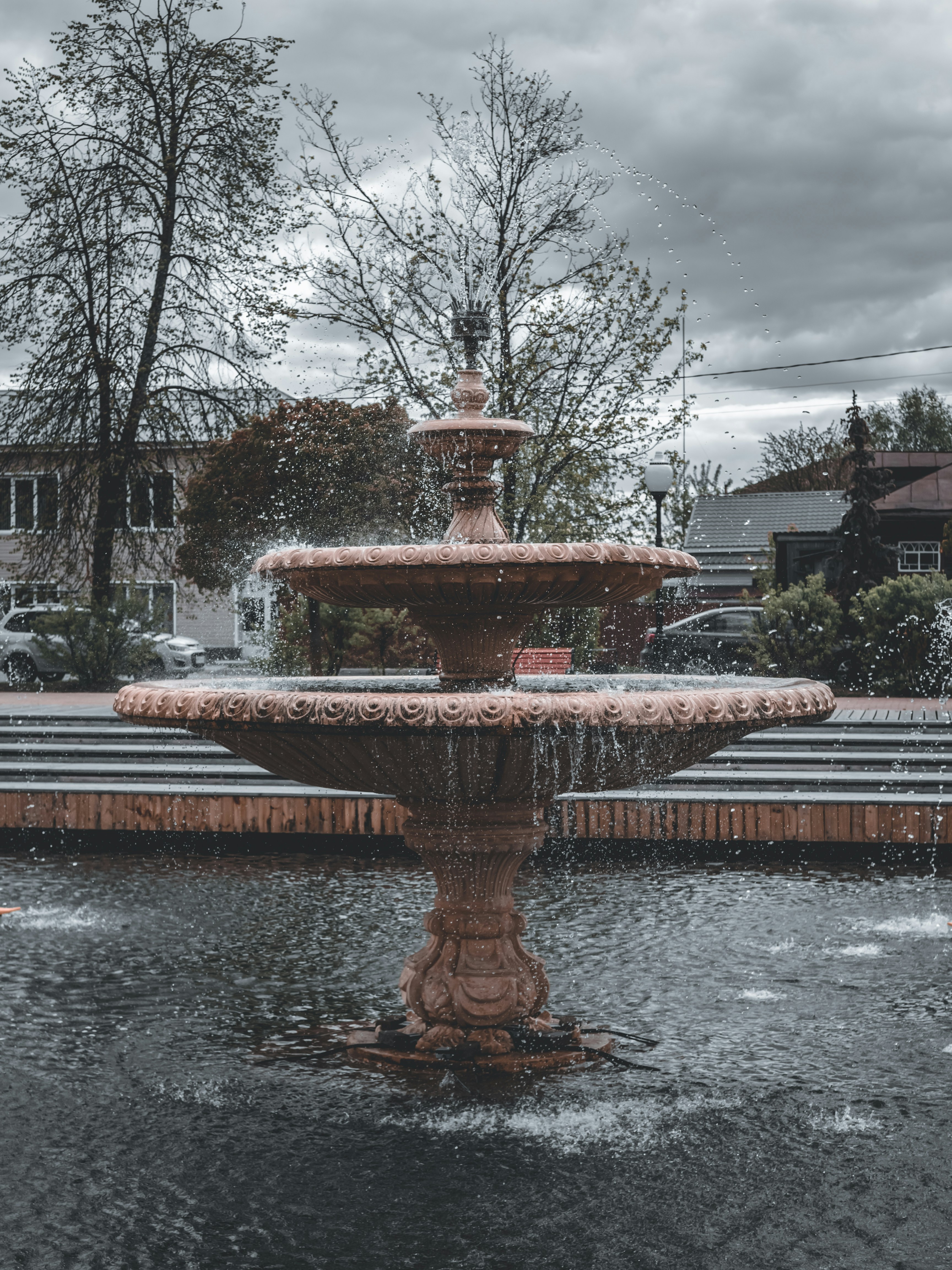 Morning Pour: A Classic Stone Fountain Framed by Quiet Streetfront