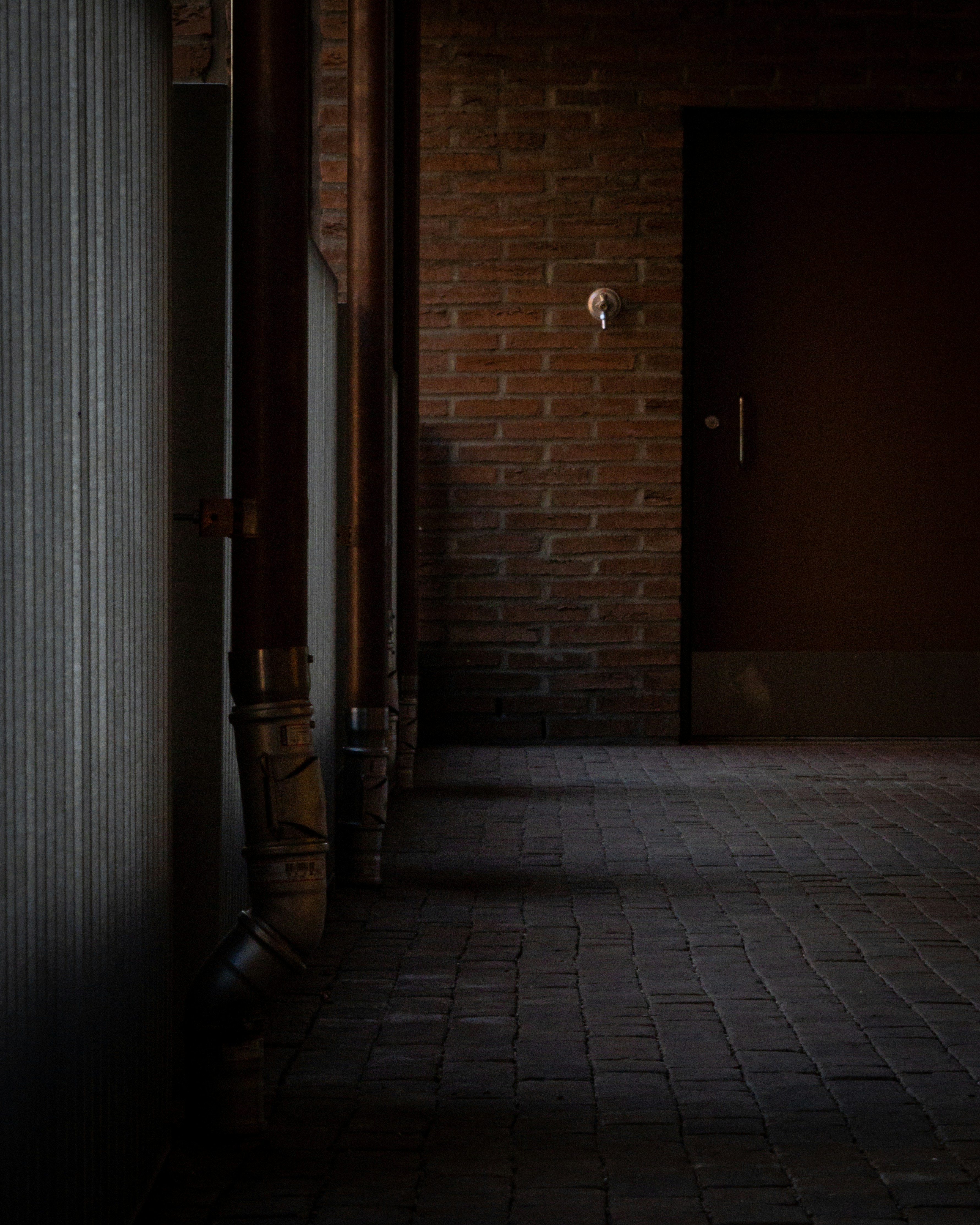 Shadowed Corridor at the Brick Threshold