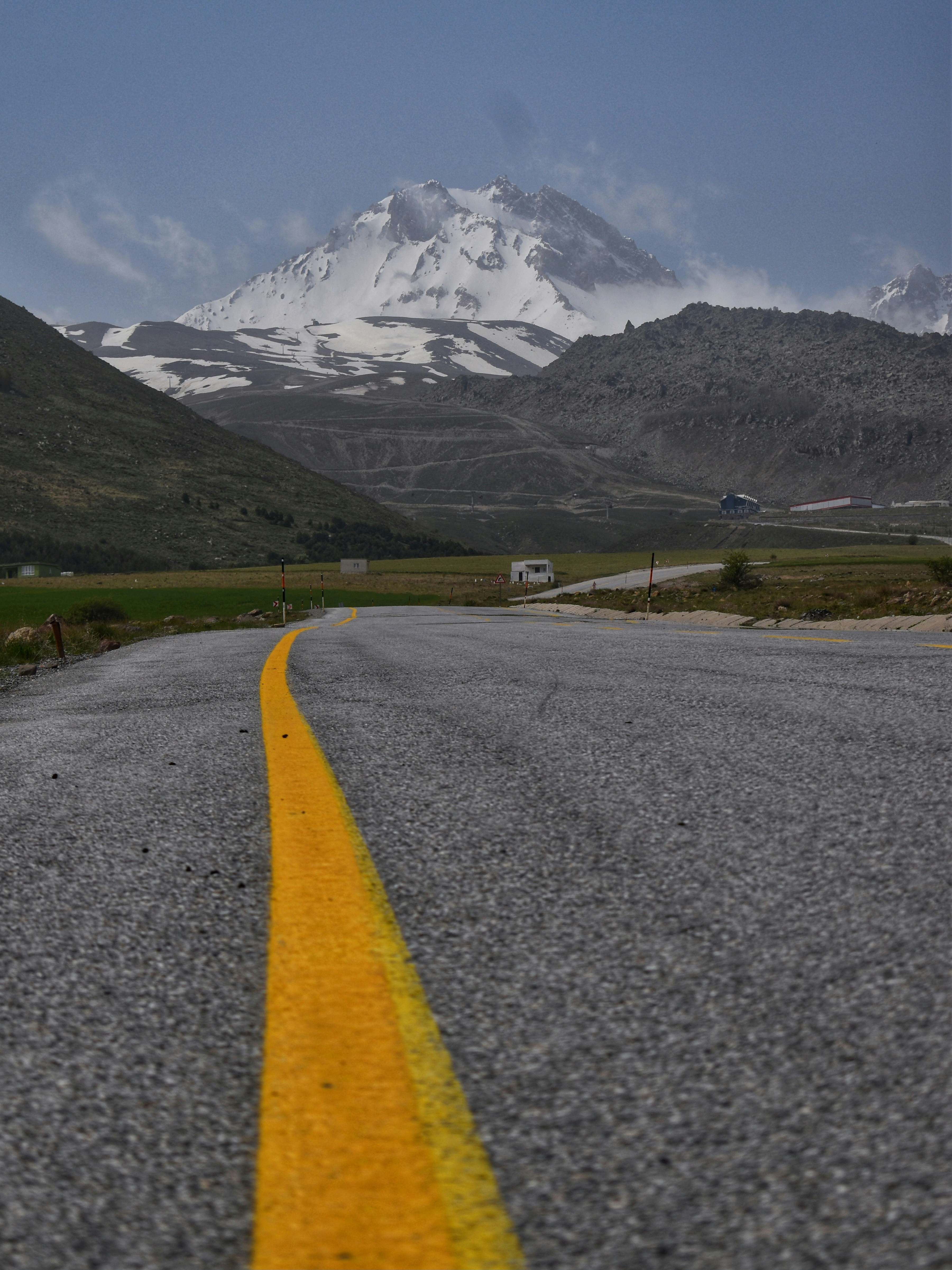 Centerline Toward Snowbound Peaks: A Quiet Mountain Road