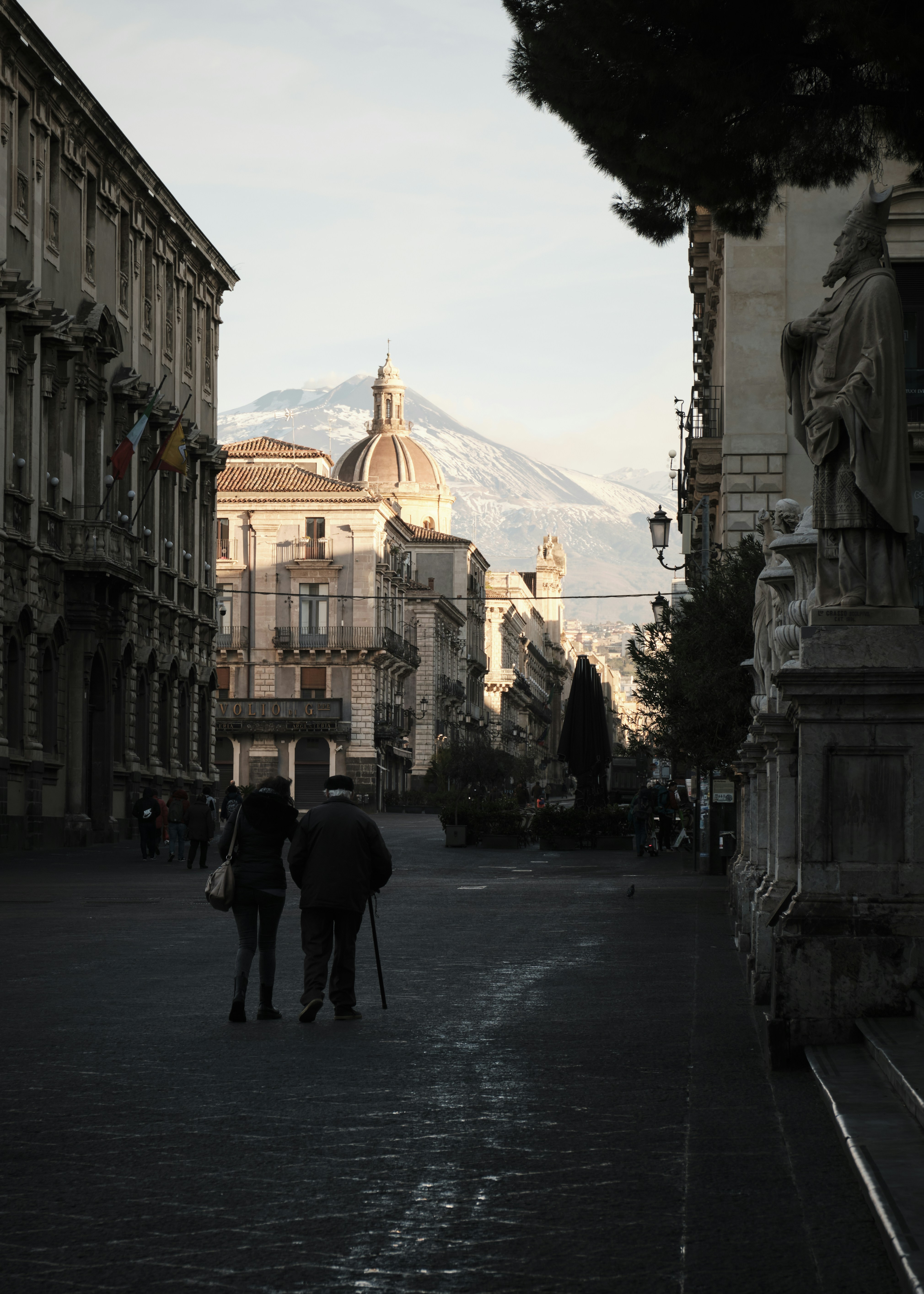 Dome-lit Arcades: Alpine Backdrop over a Quiet European Street