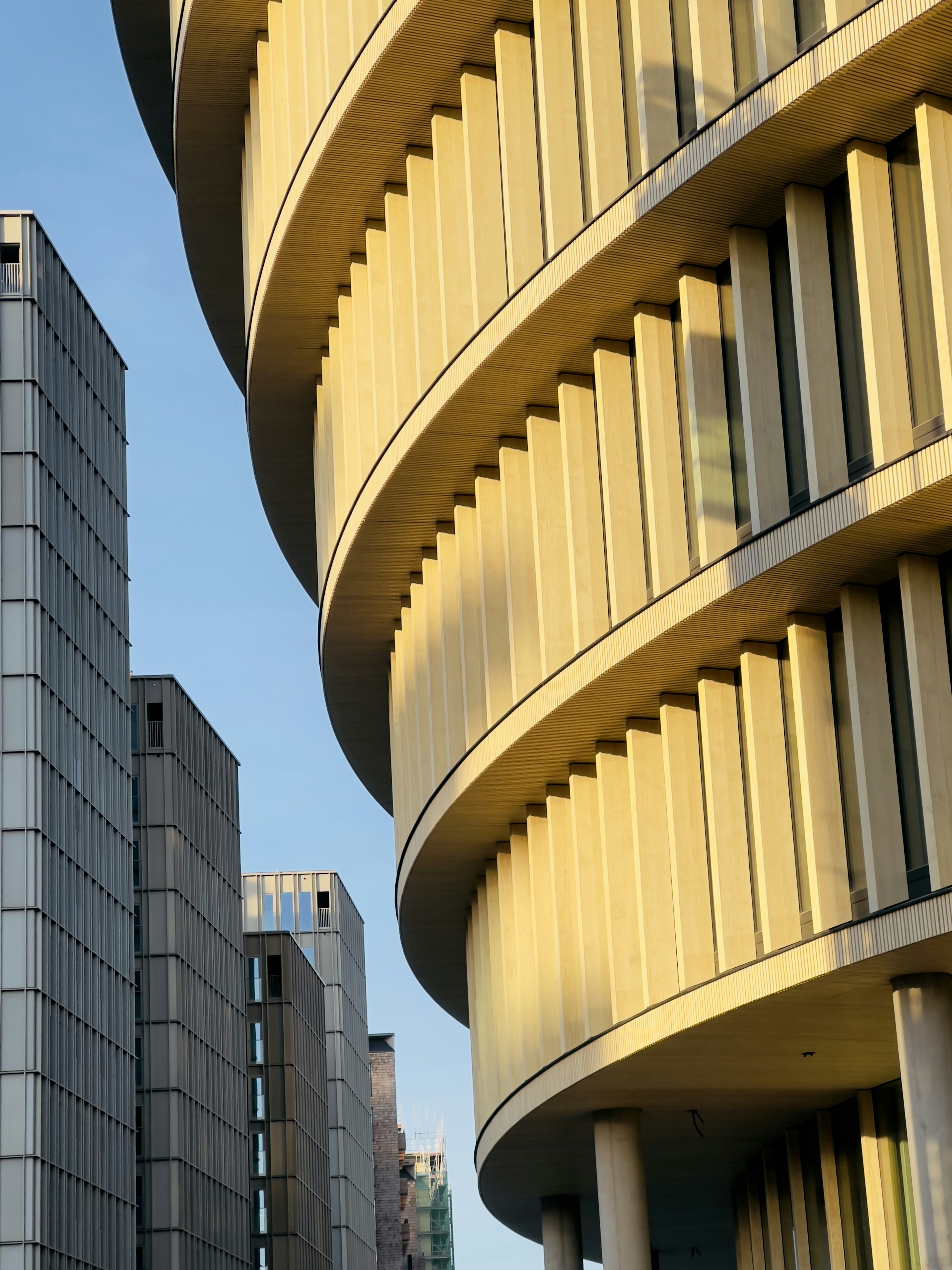 A tall building next to a very tall building photo – Free High rise ...