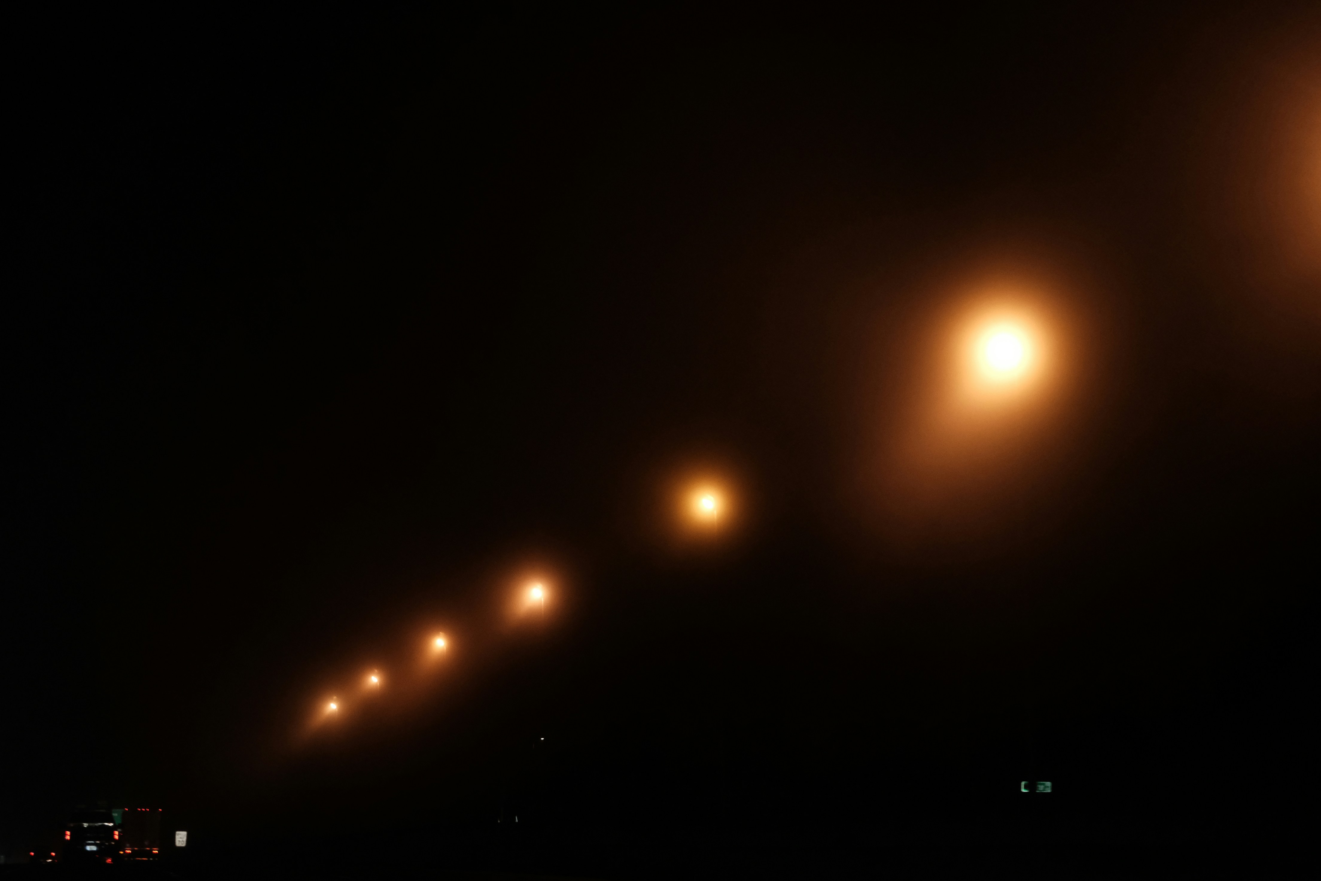 Ember Arc: Distant Streetlights Tracing a Nightline