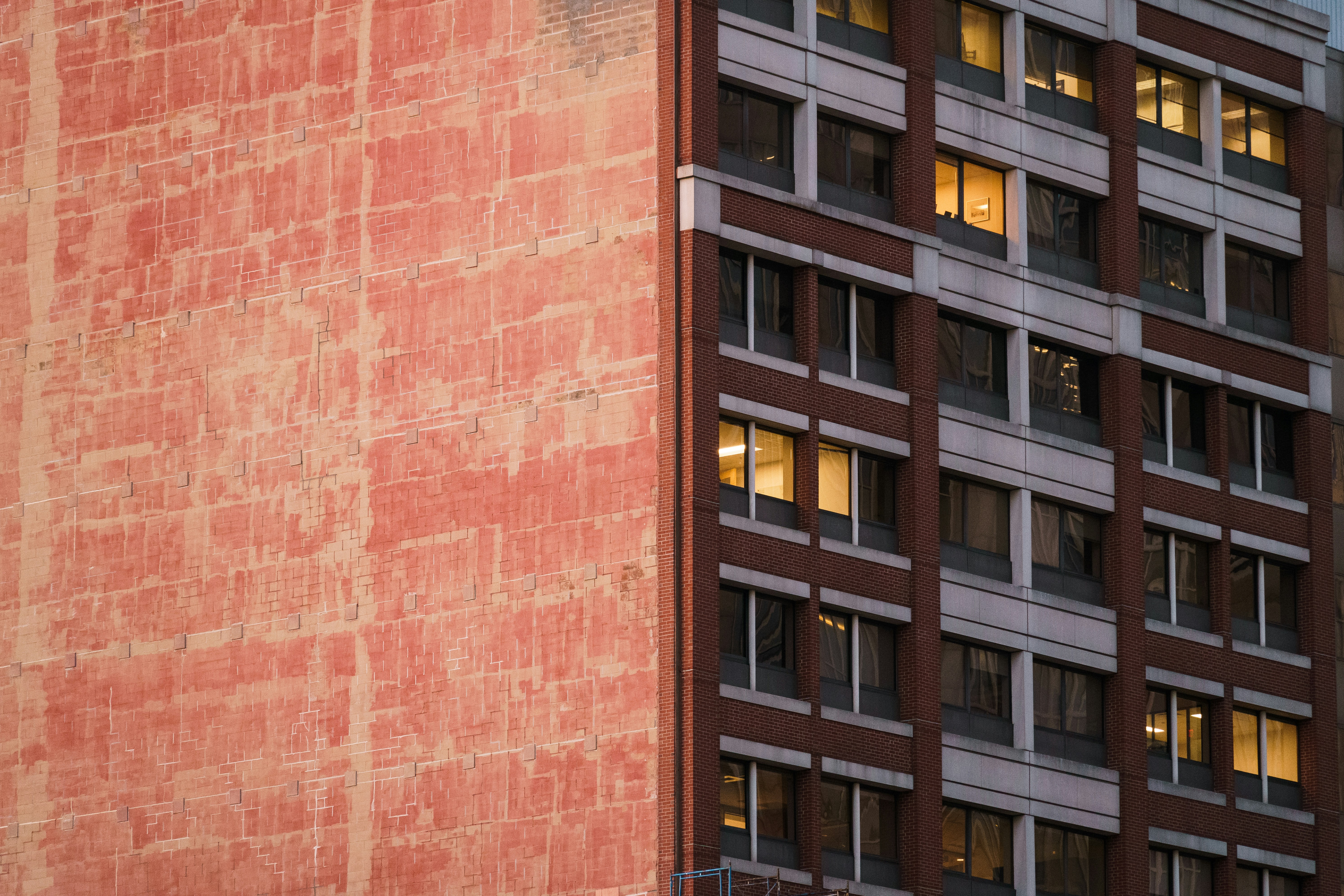 A tall red brick building next to a tall red brick building photo ...