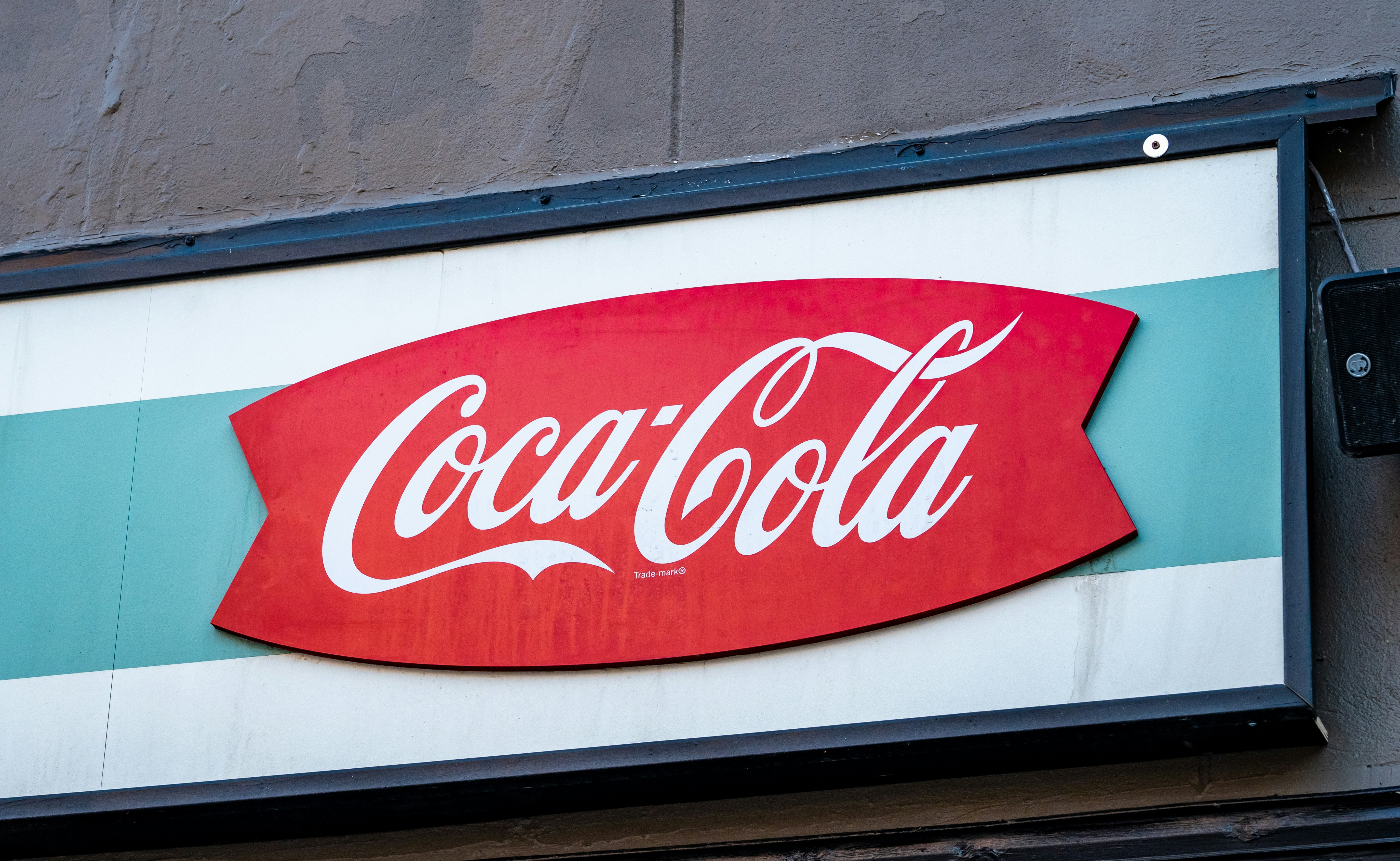 A coca cola sign on the side of a building photo – Free Colorful Image ...