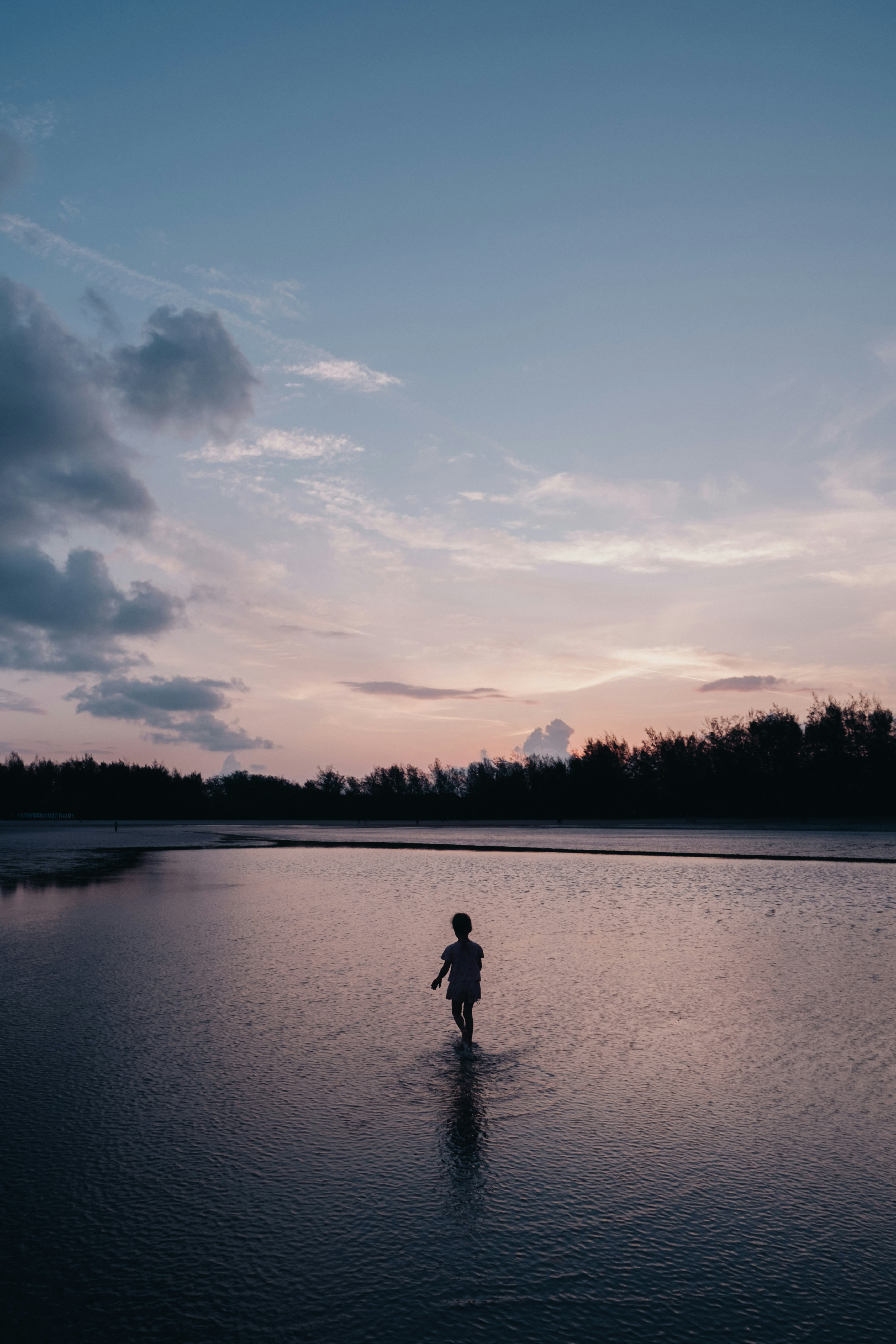 A person wading in a body of water at sunset photo – Free Thailand ...