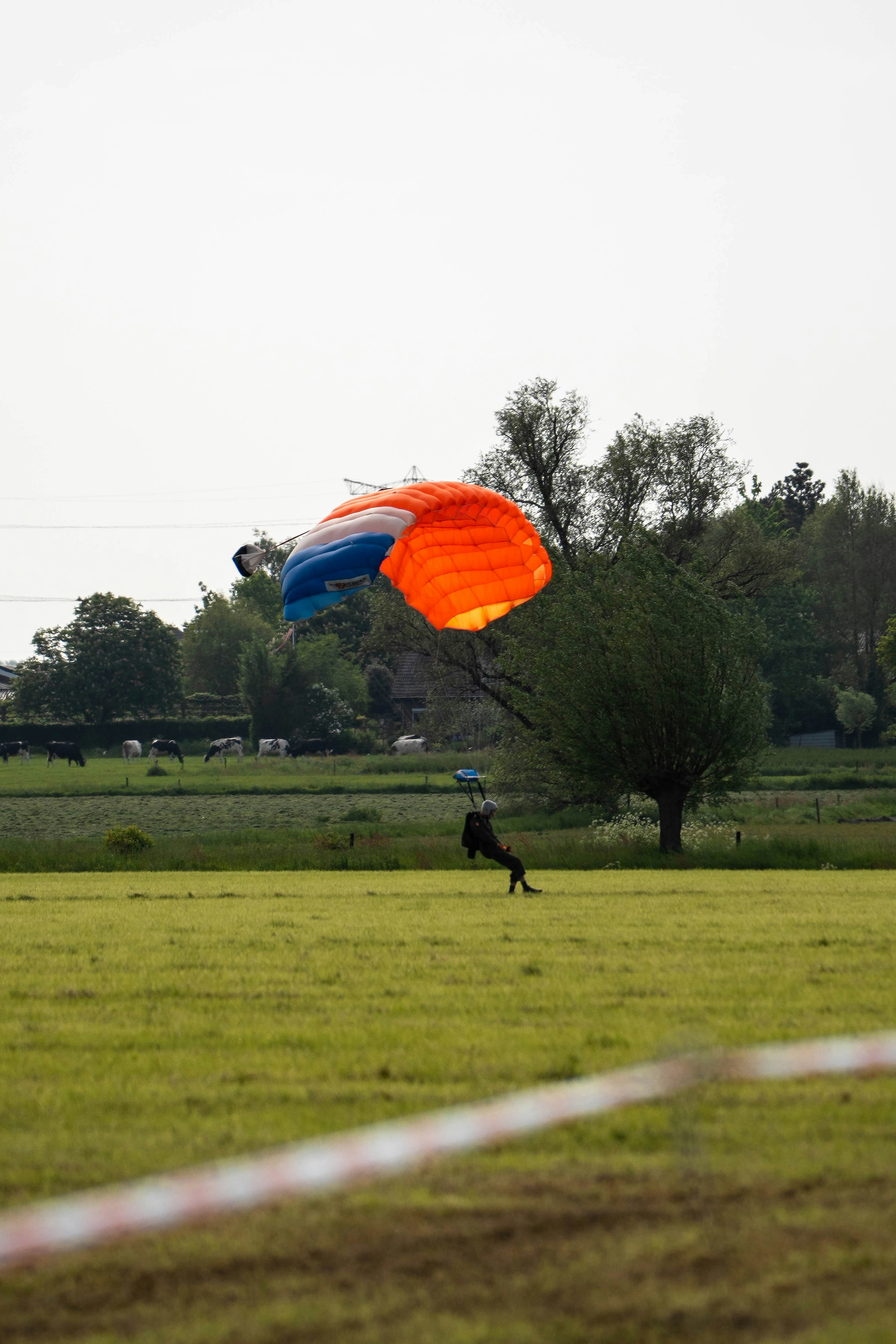 Orange Parachute Over a Quiet Field