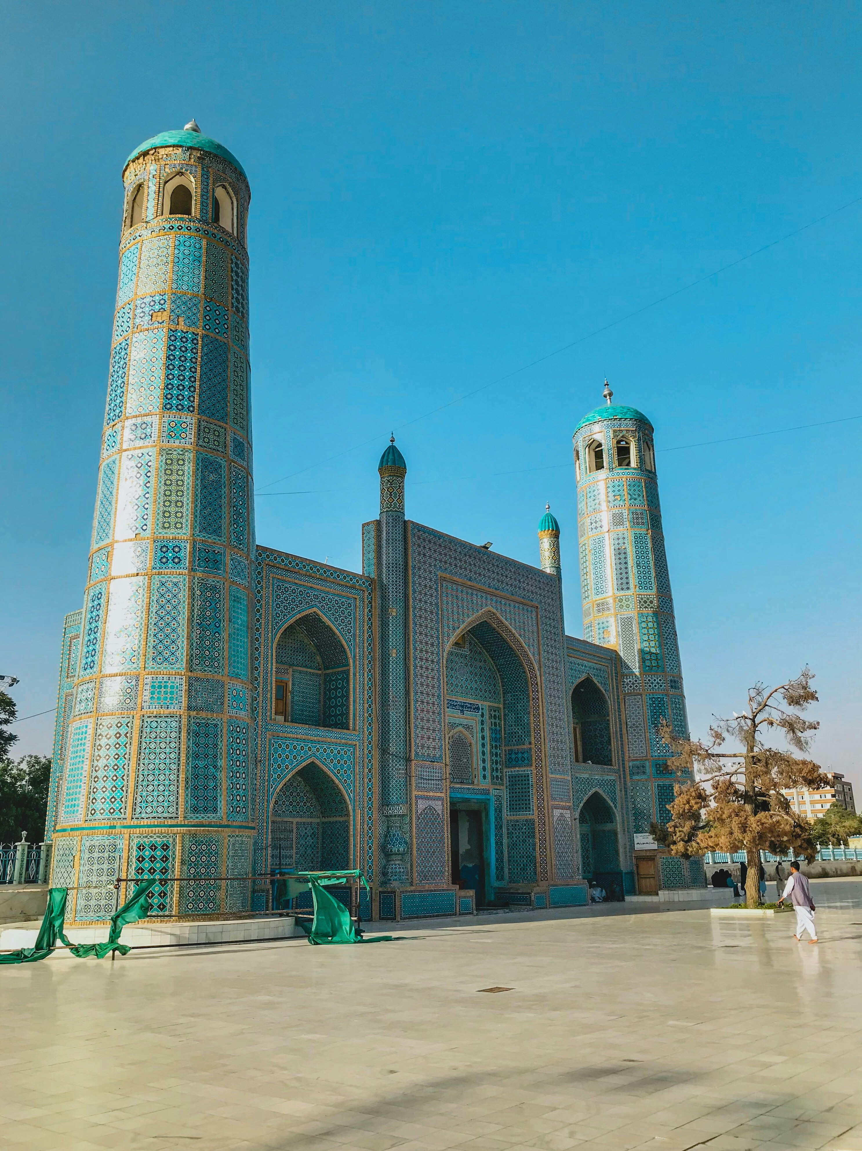 Turquoise Tile Mosque with Twin Minarets Against a Pristine Blue Sky