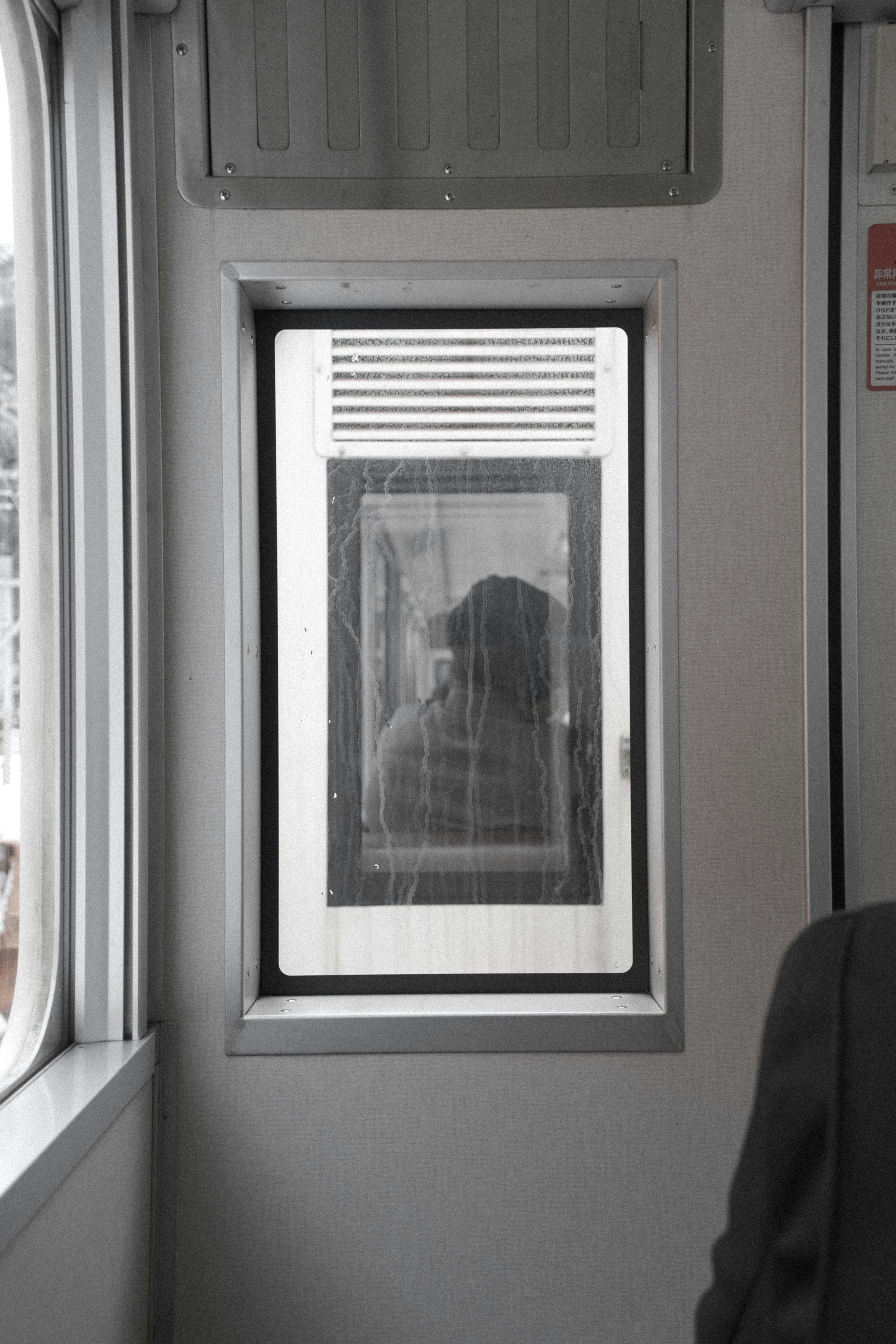 Reflection in Transit: A Quiet Silhouette in a Train Window