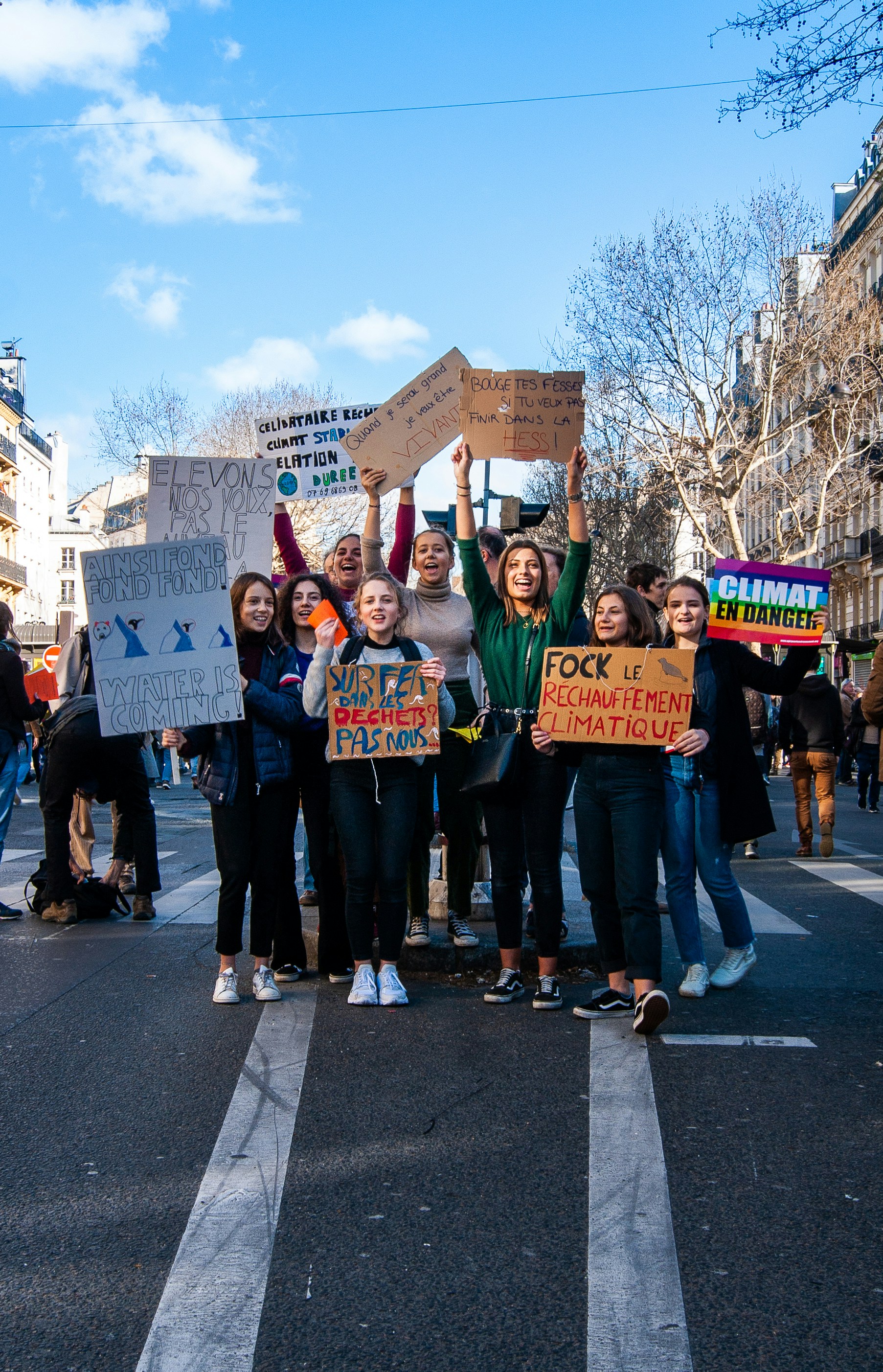 A group of people holding up signs in the street photo – Free France ...