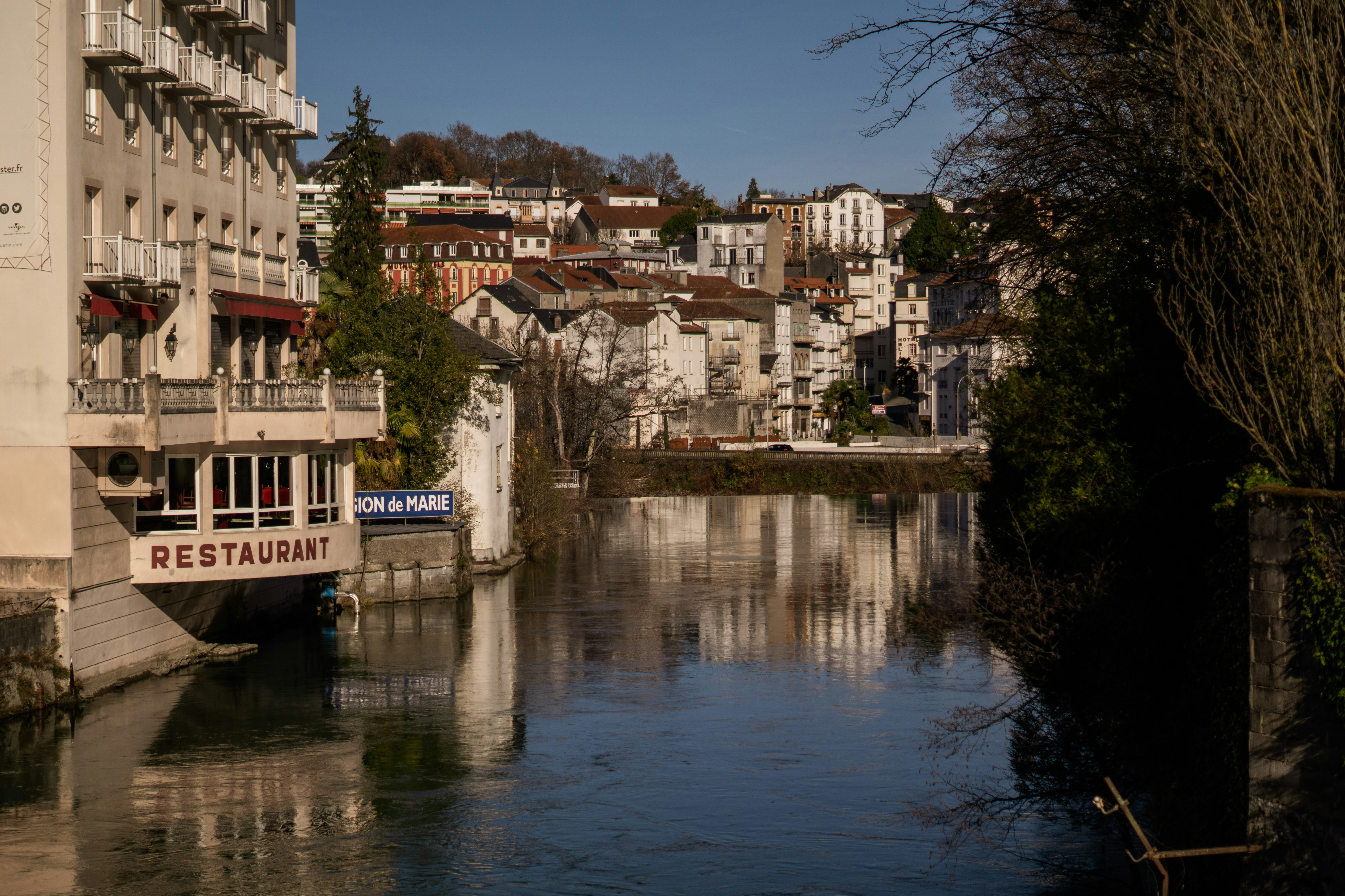 a river running through a city next to tall buildings