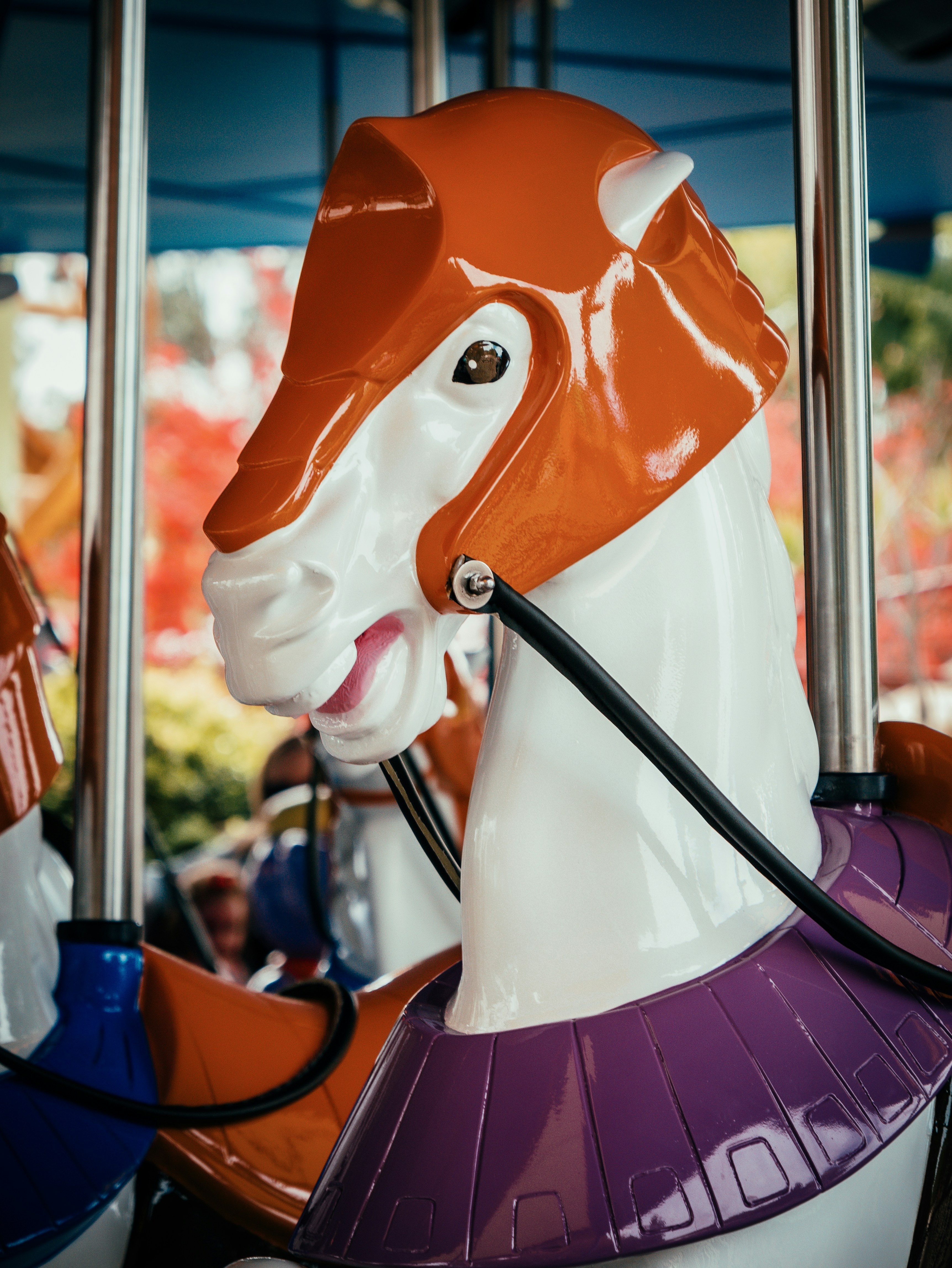 Gleaming Carousel Horse Head Framed by Steel Poles