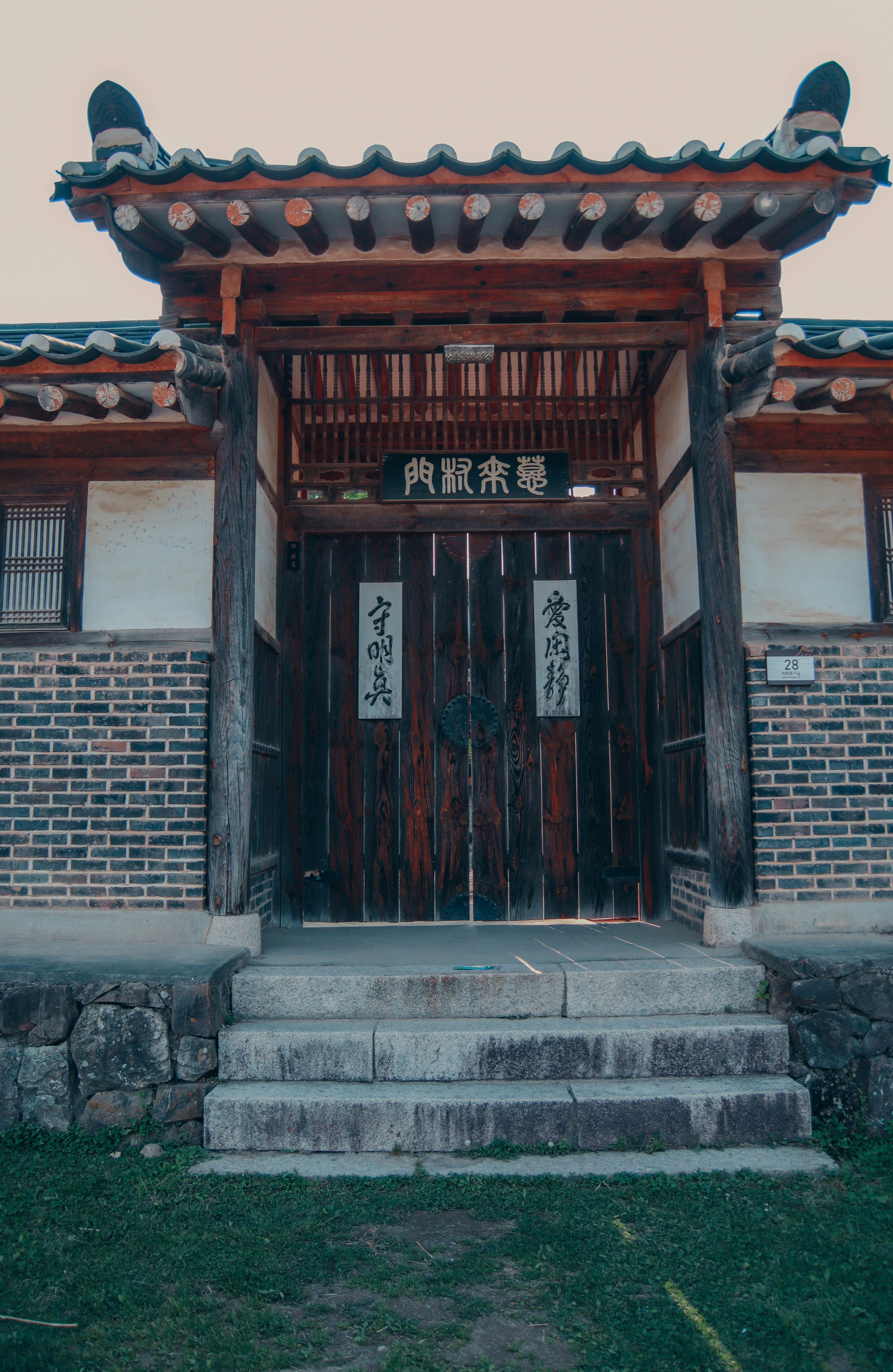 a building with a wooden door and steps leading up to it