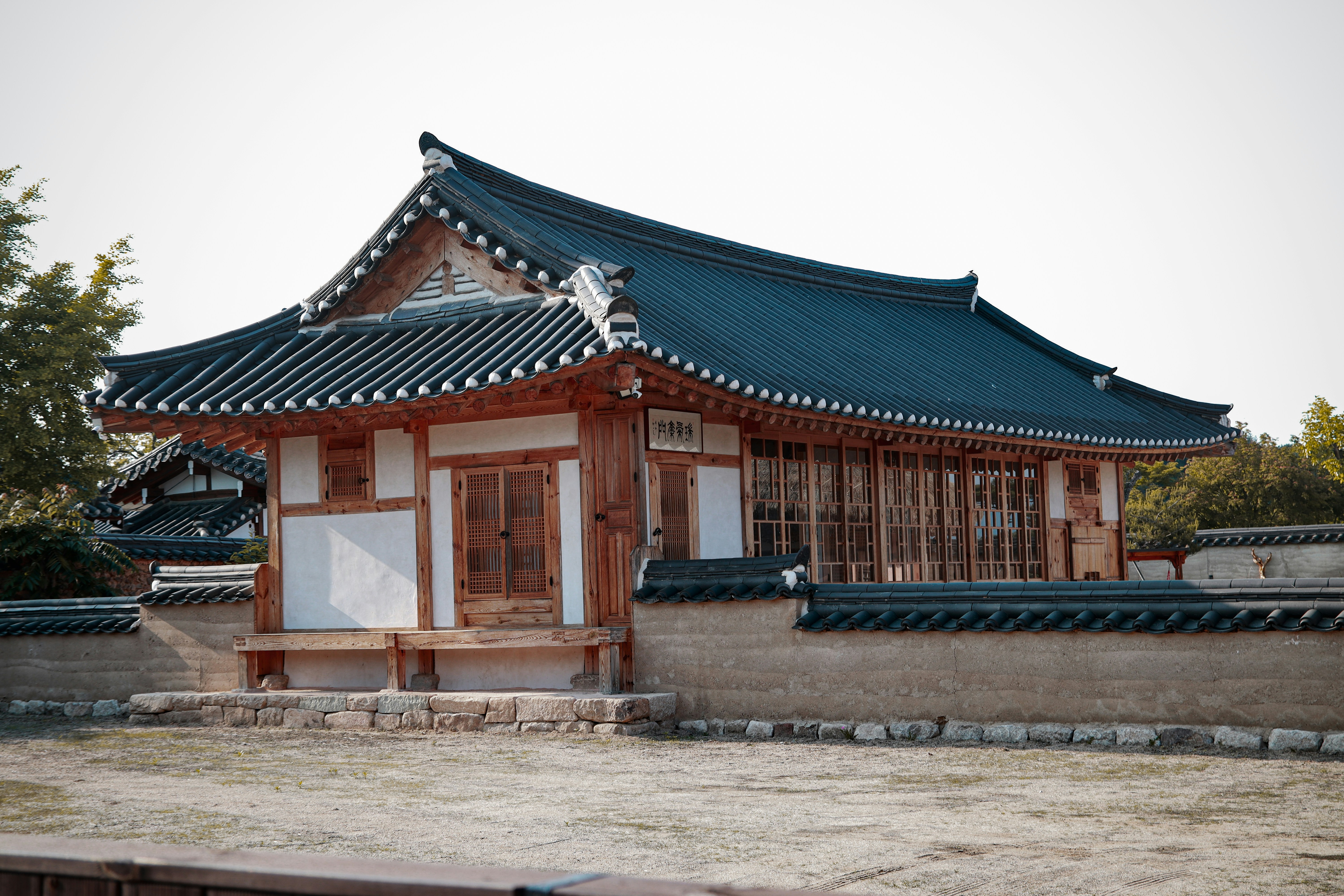 a small building with a blue roof and windows