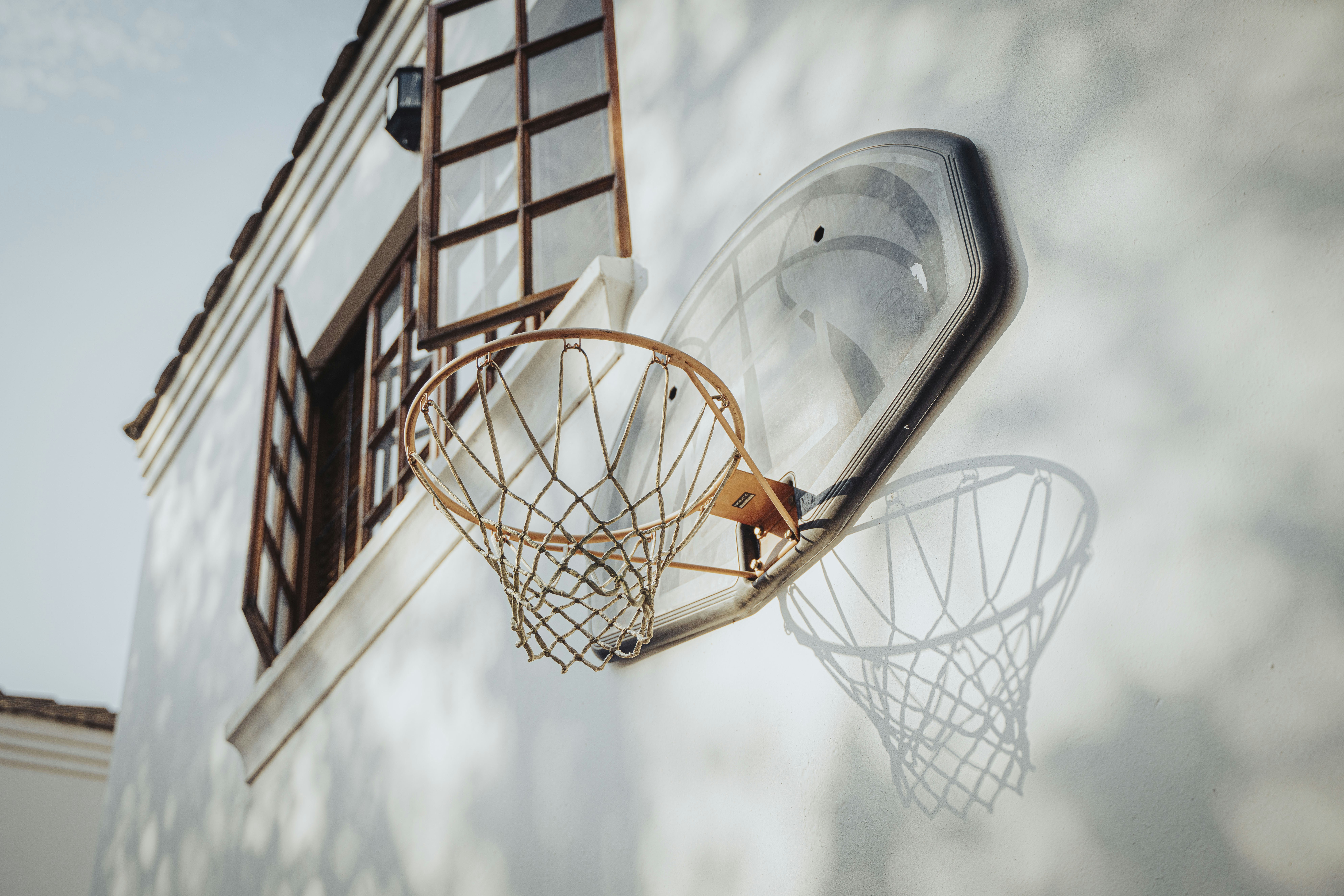 A basketball going through the hoop of a basketball hoop photo – Free ...