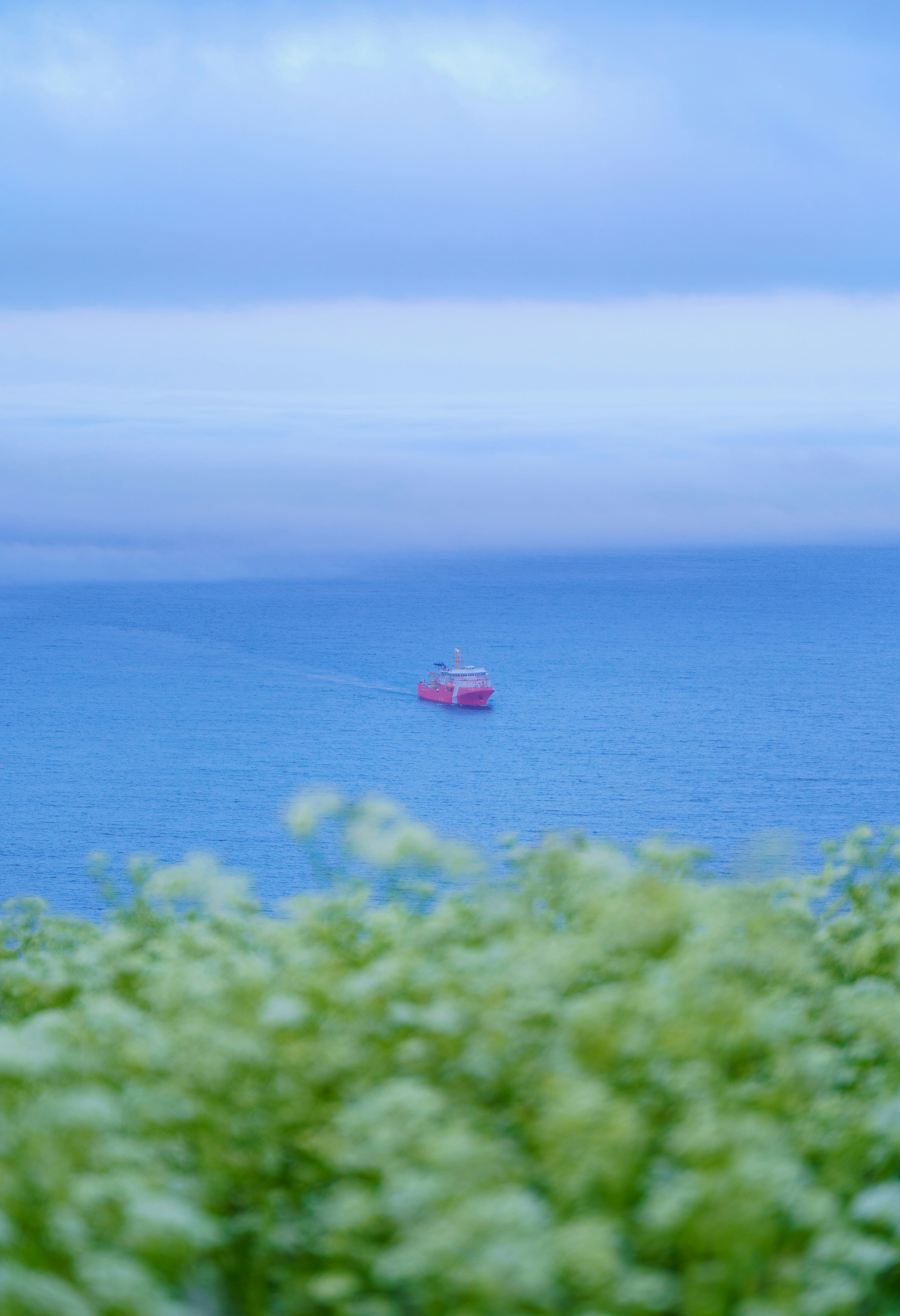 a small boat in the middle of a large body of water