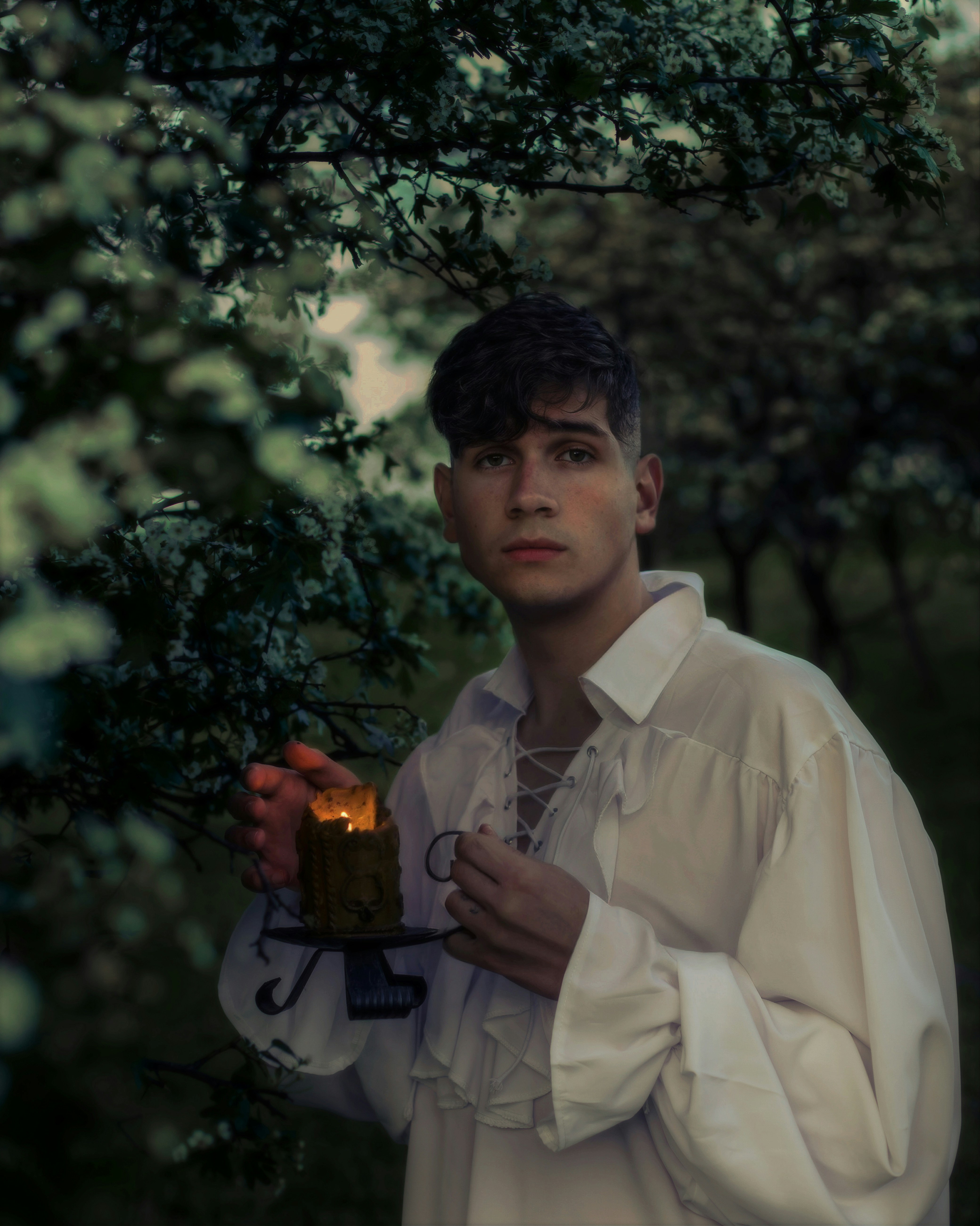 A man in a white shirt holding a lit candle photo – Free Portrait Image ...