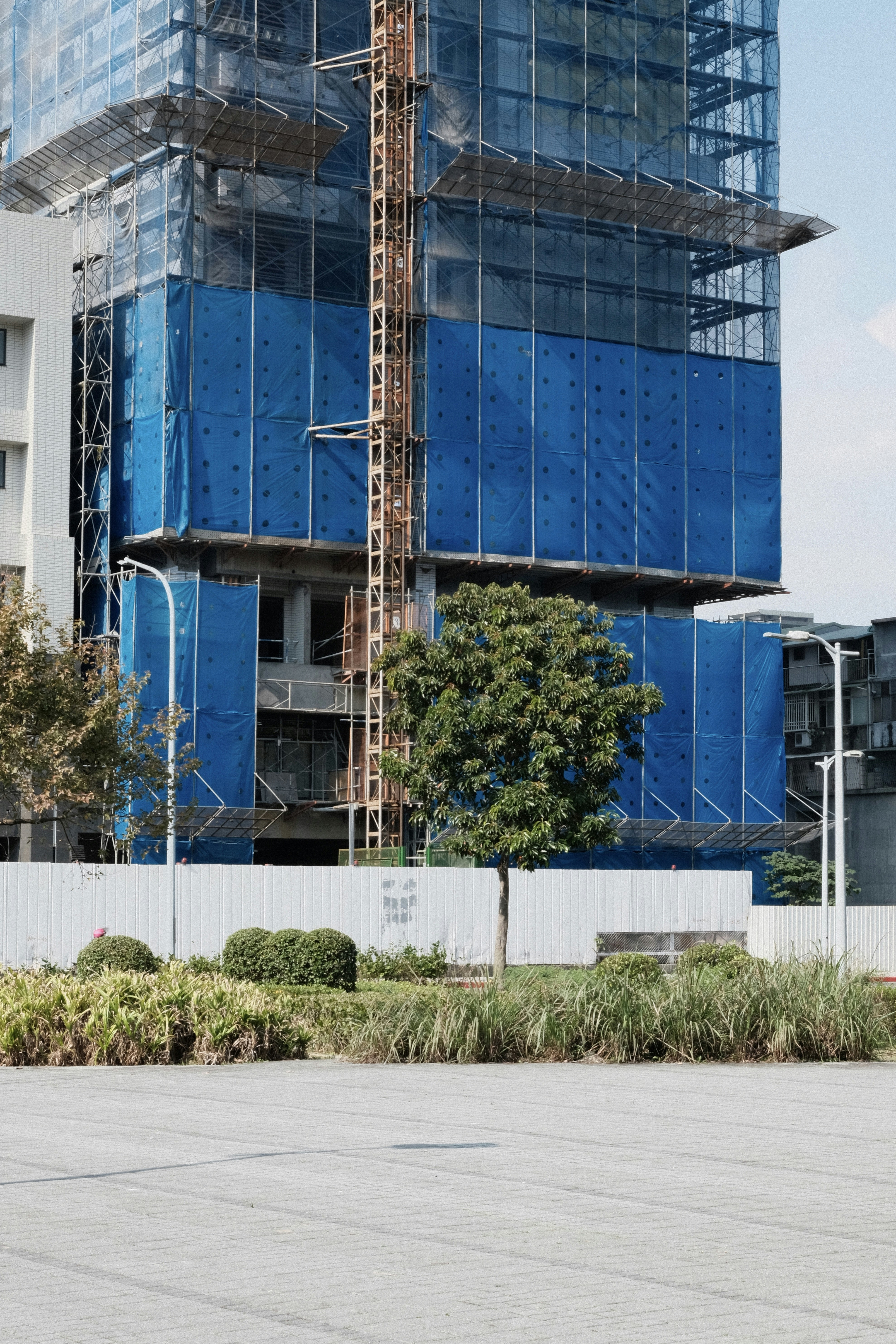 Blue Scaffolded Skeleton: Tower Under Construction