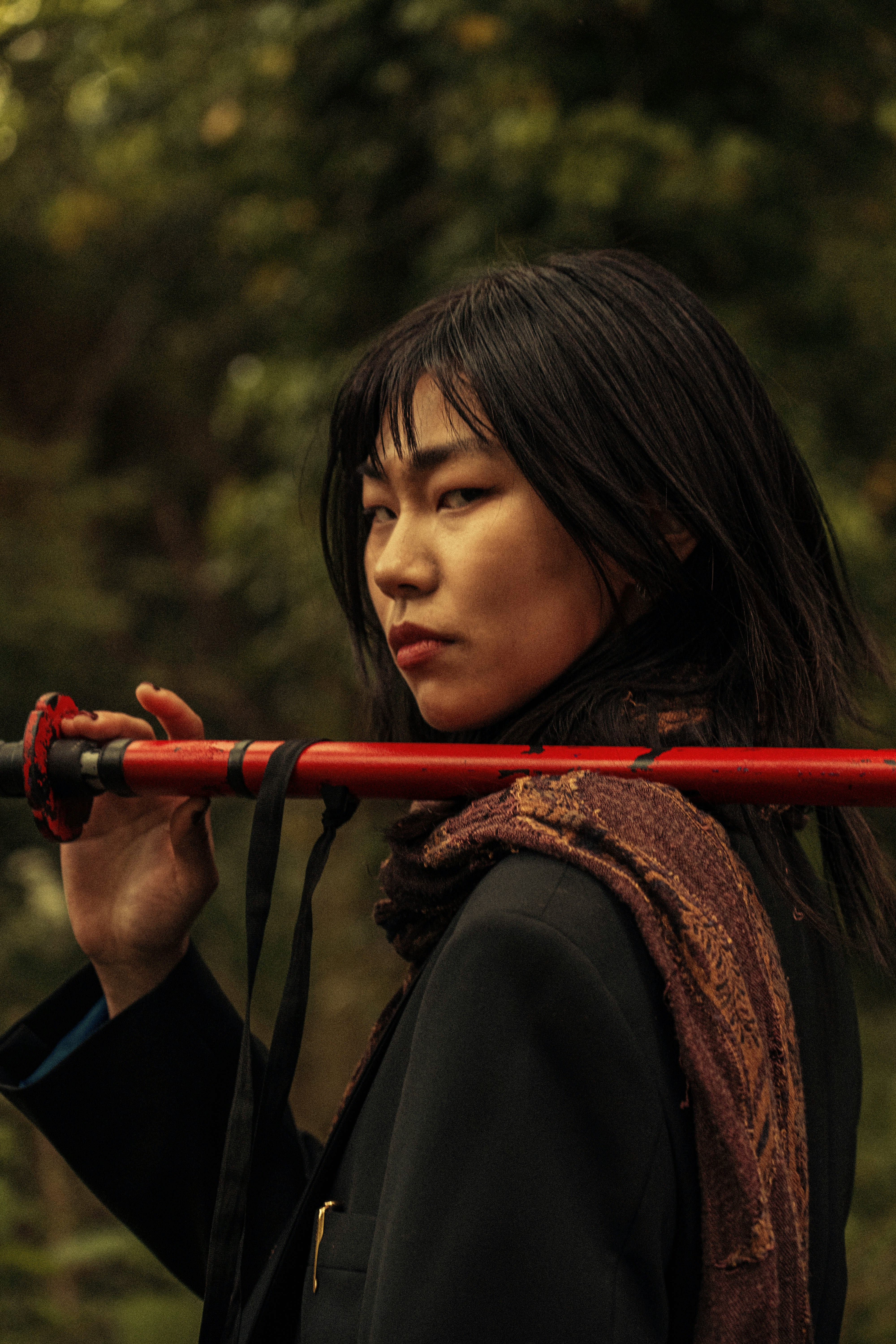 A woman holding a red stick in her hand photo – Free Red Image on Unsplash