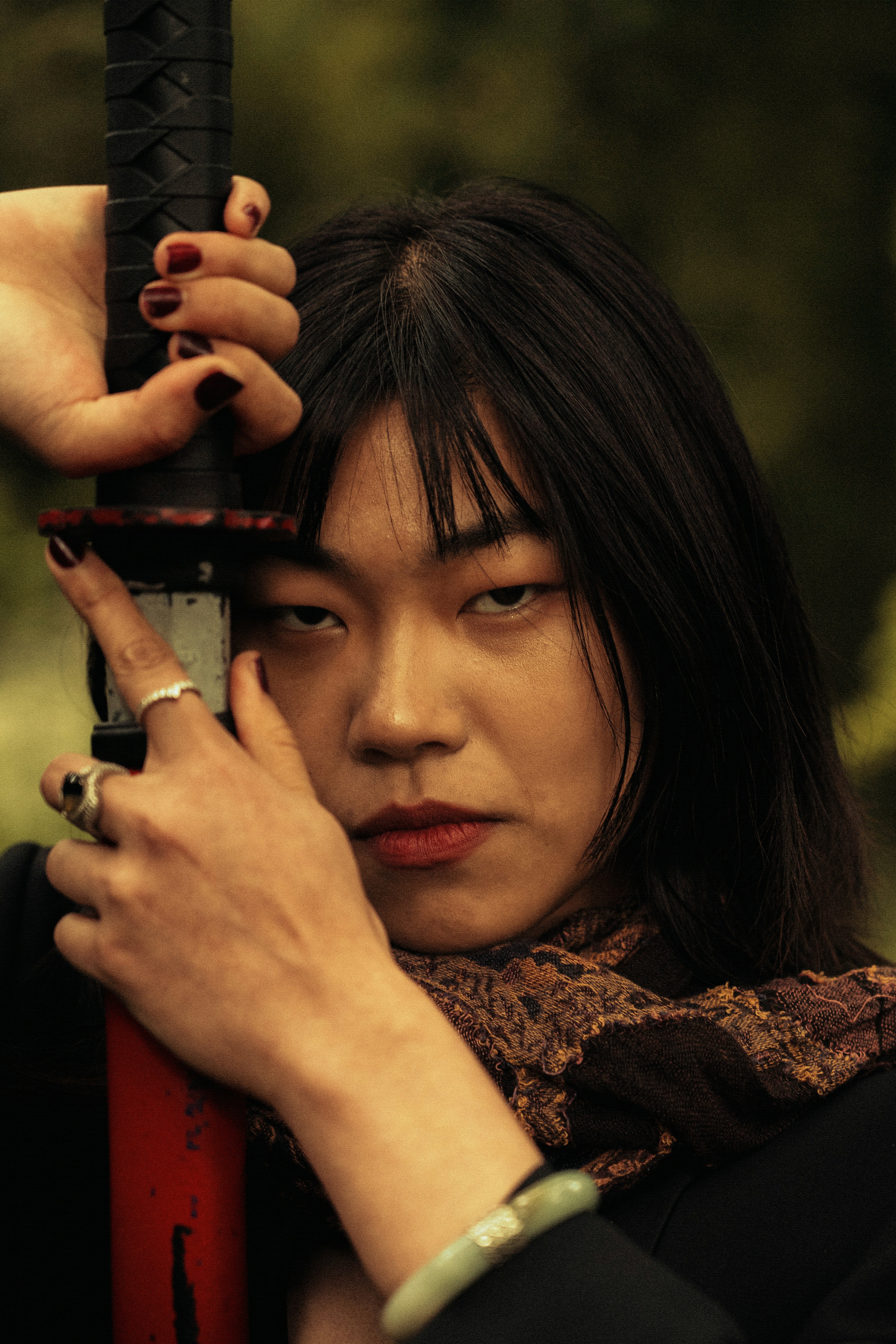 Eyes in Focus Behind the Blade: Portrait with a Sword
