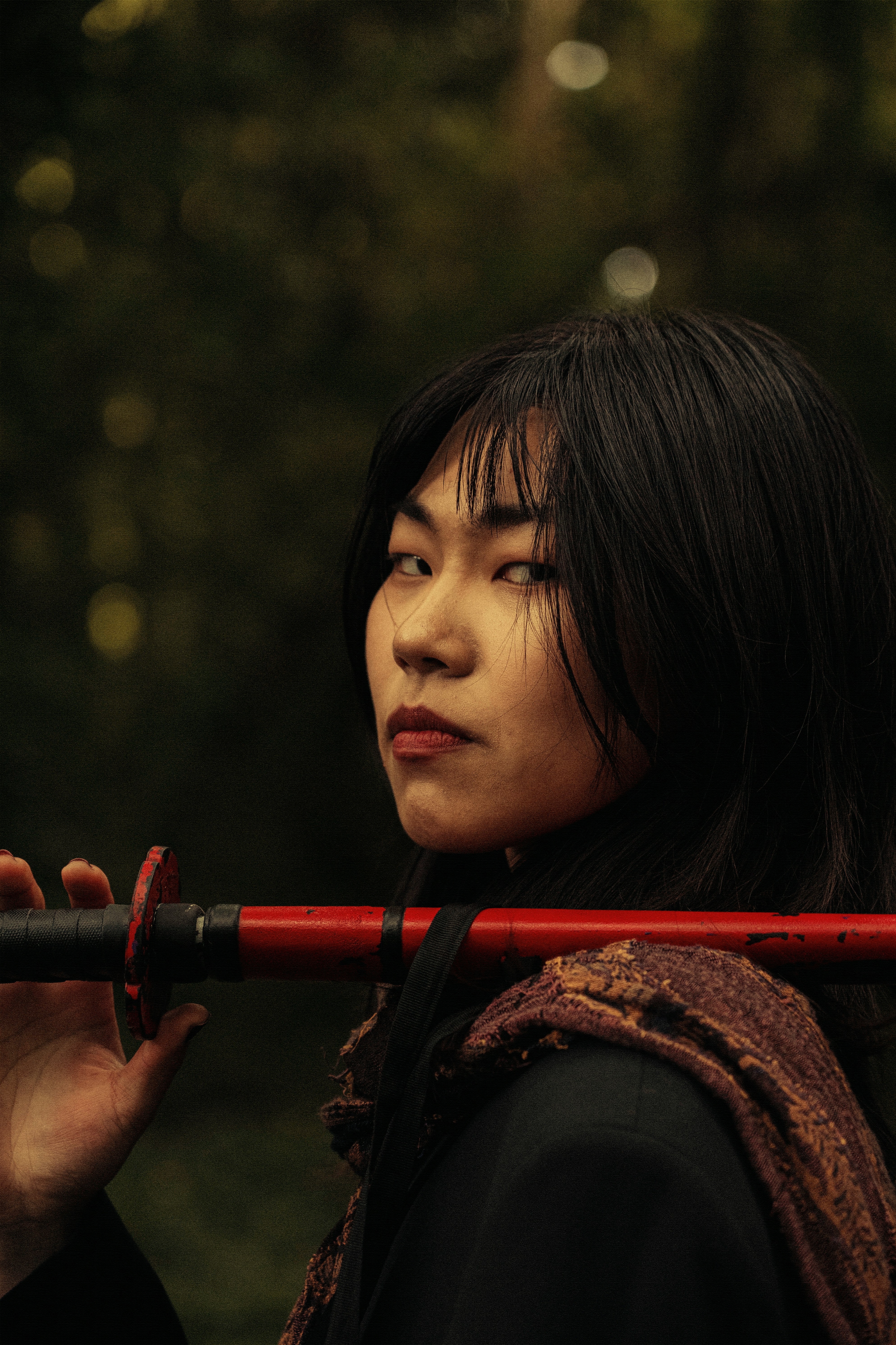 A woman is holding a red stick in her hand photo – Free Red Image on ...