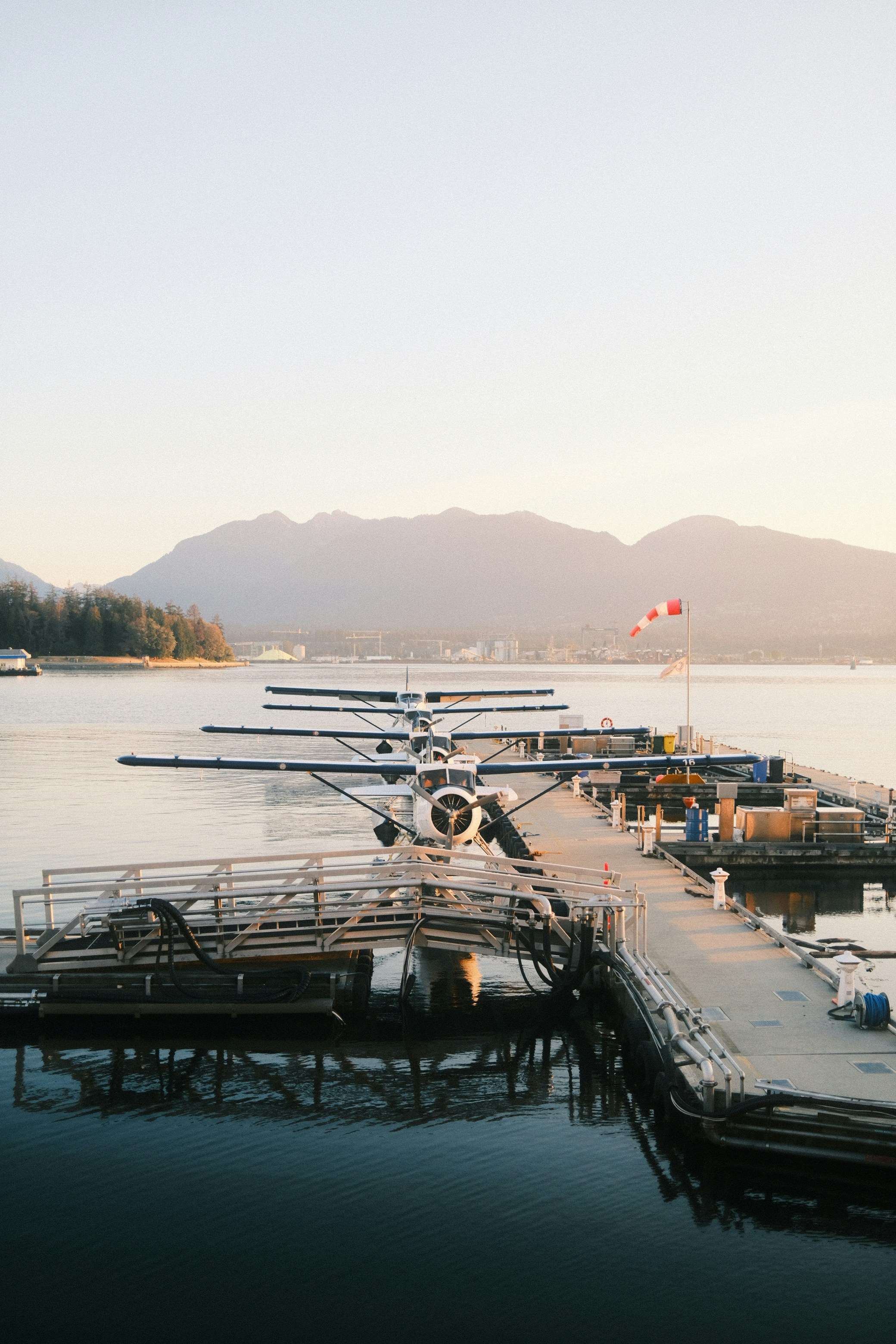 Dawn on the Floatplane Dock: Seaplane Framed by Calm Lake and Distant Peaks
