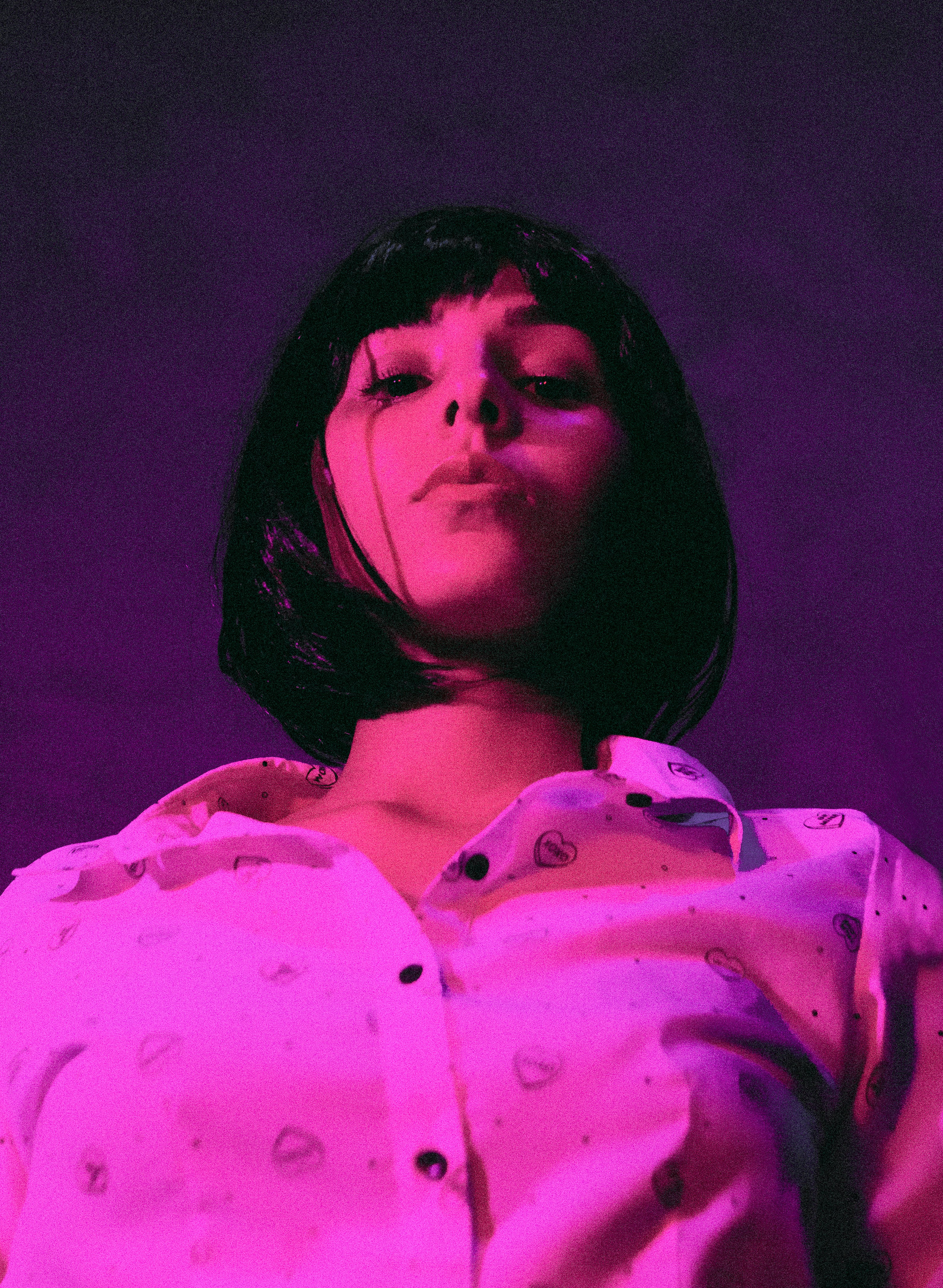 Under Magenta Veil: A Low-Angle Portrait in Purple Light