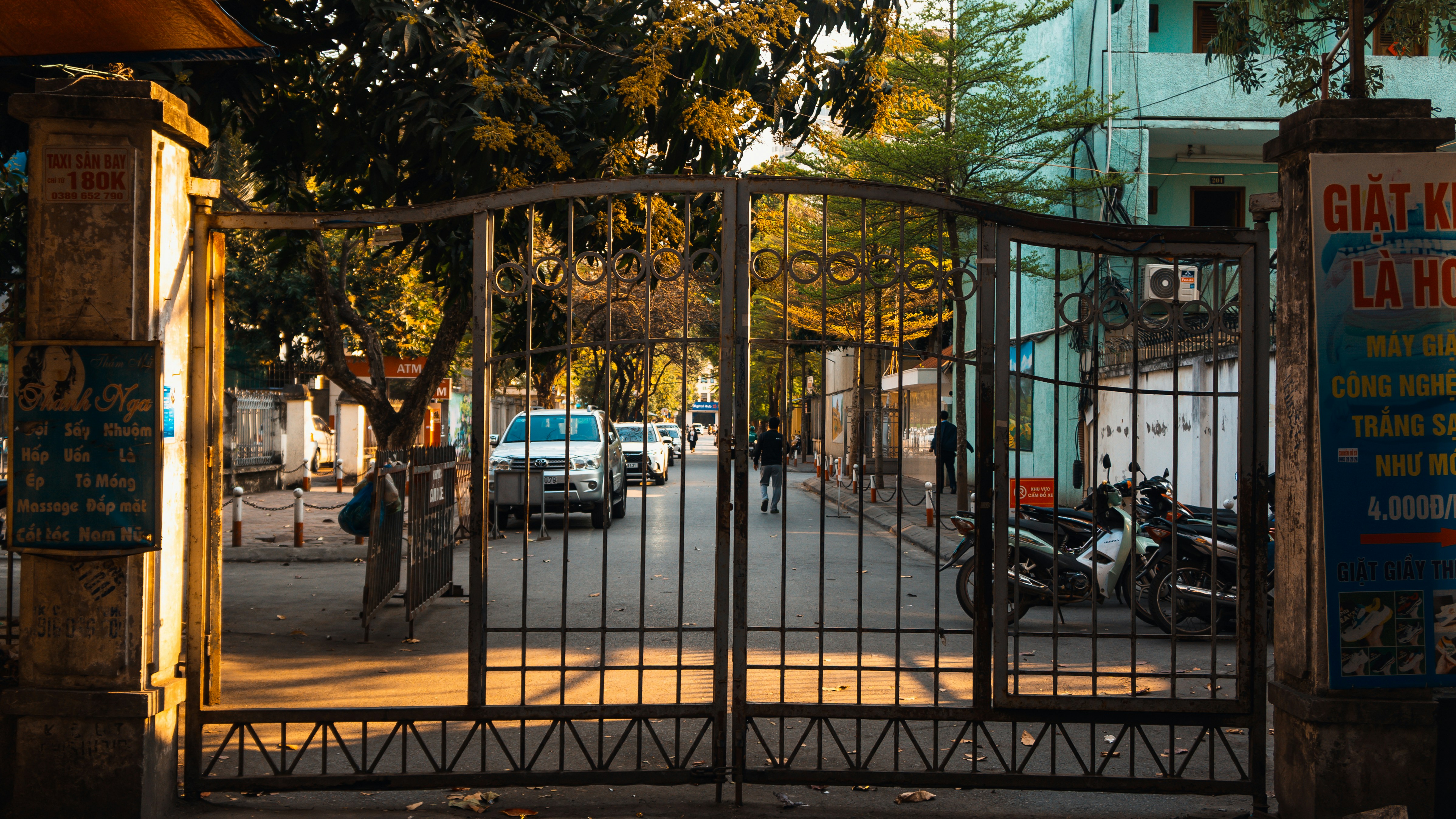 Through the Iron Gate, Morning Light Reveals a Quiet Urban Corridor