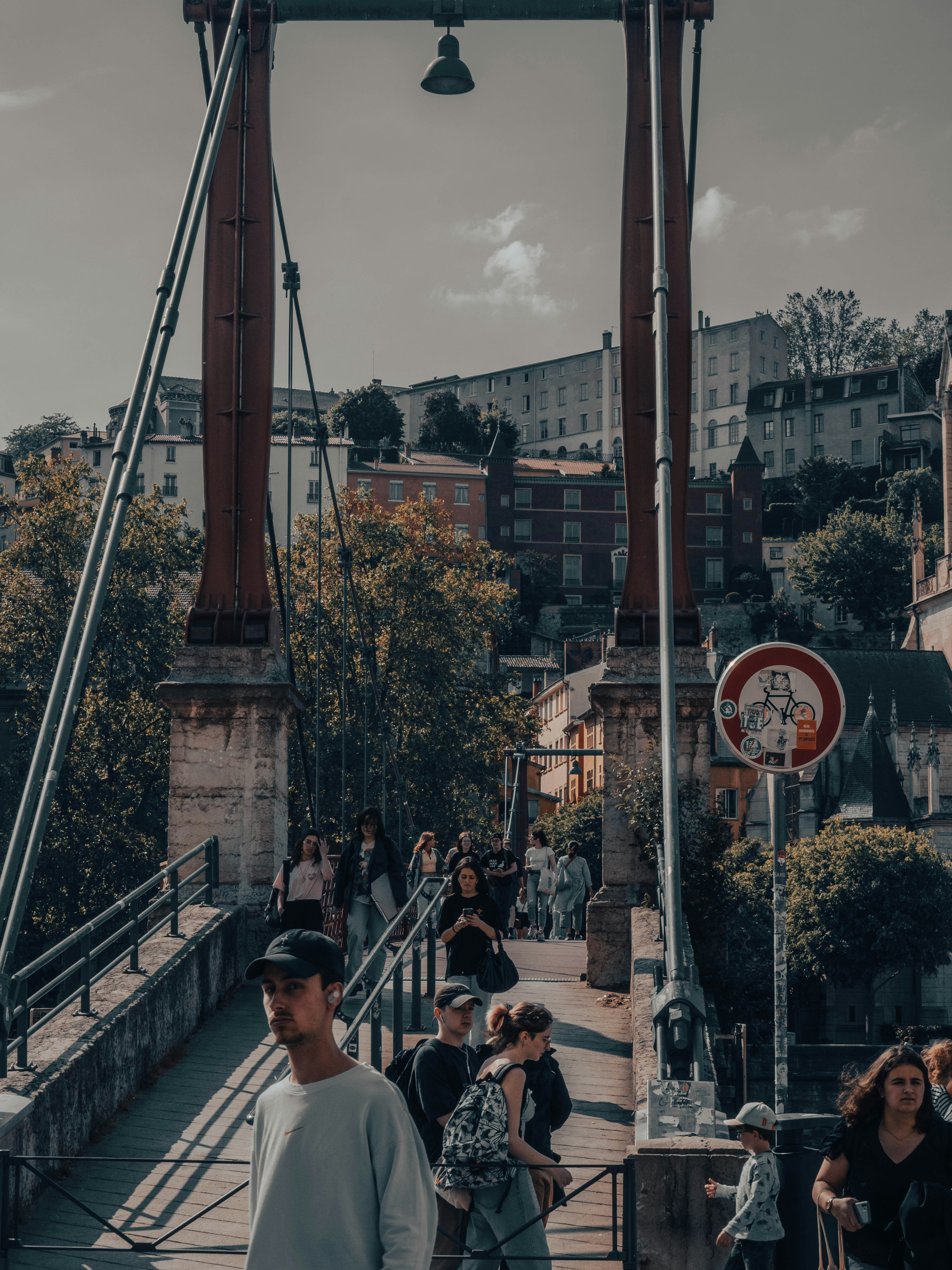 A group of people walking across a bridge photo – Free France Image on ...