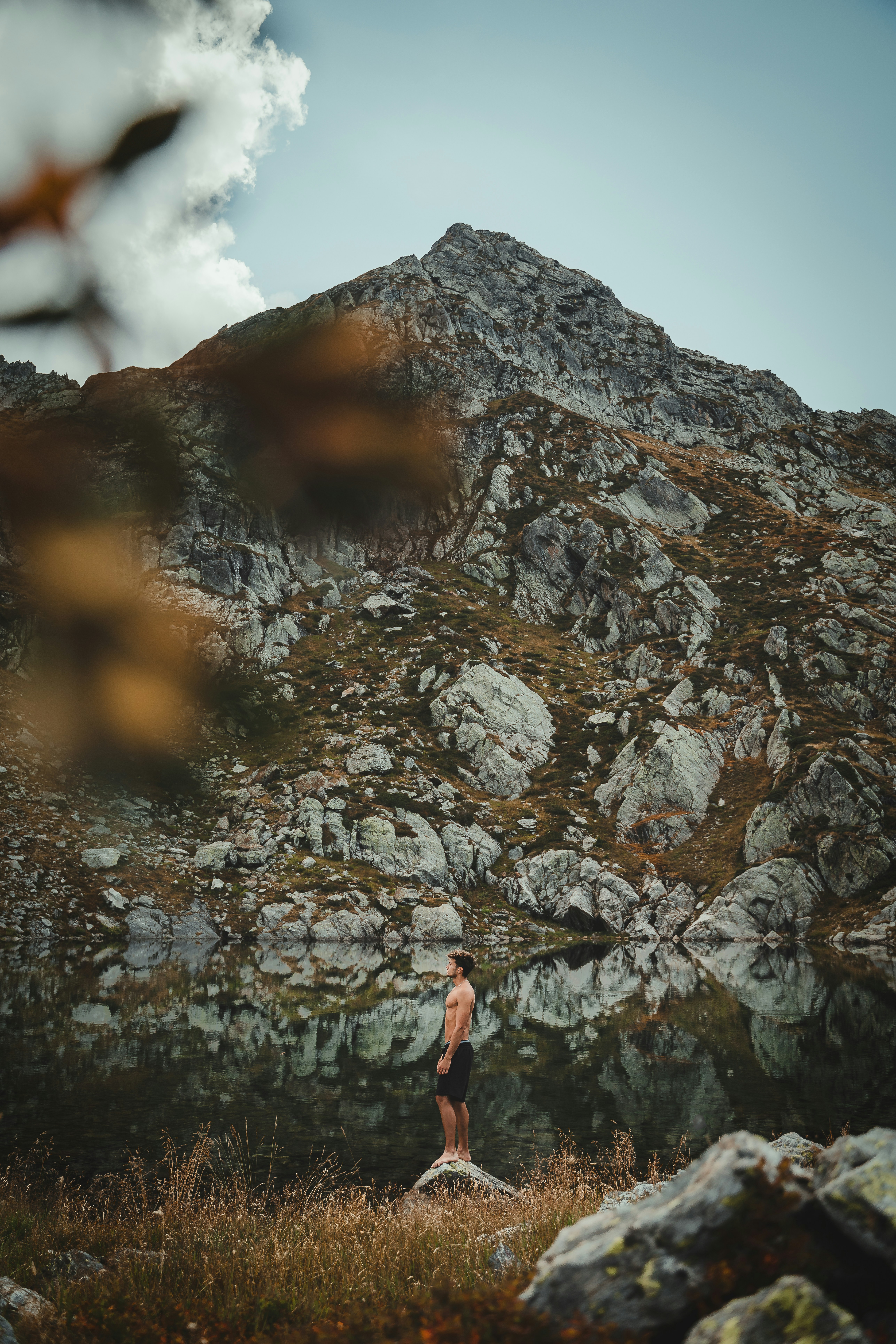 Lone Wanderer on a Rocky Ridge by a Glassy Tarn